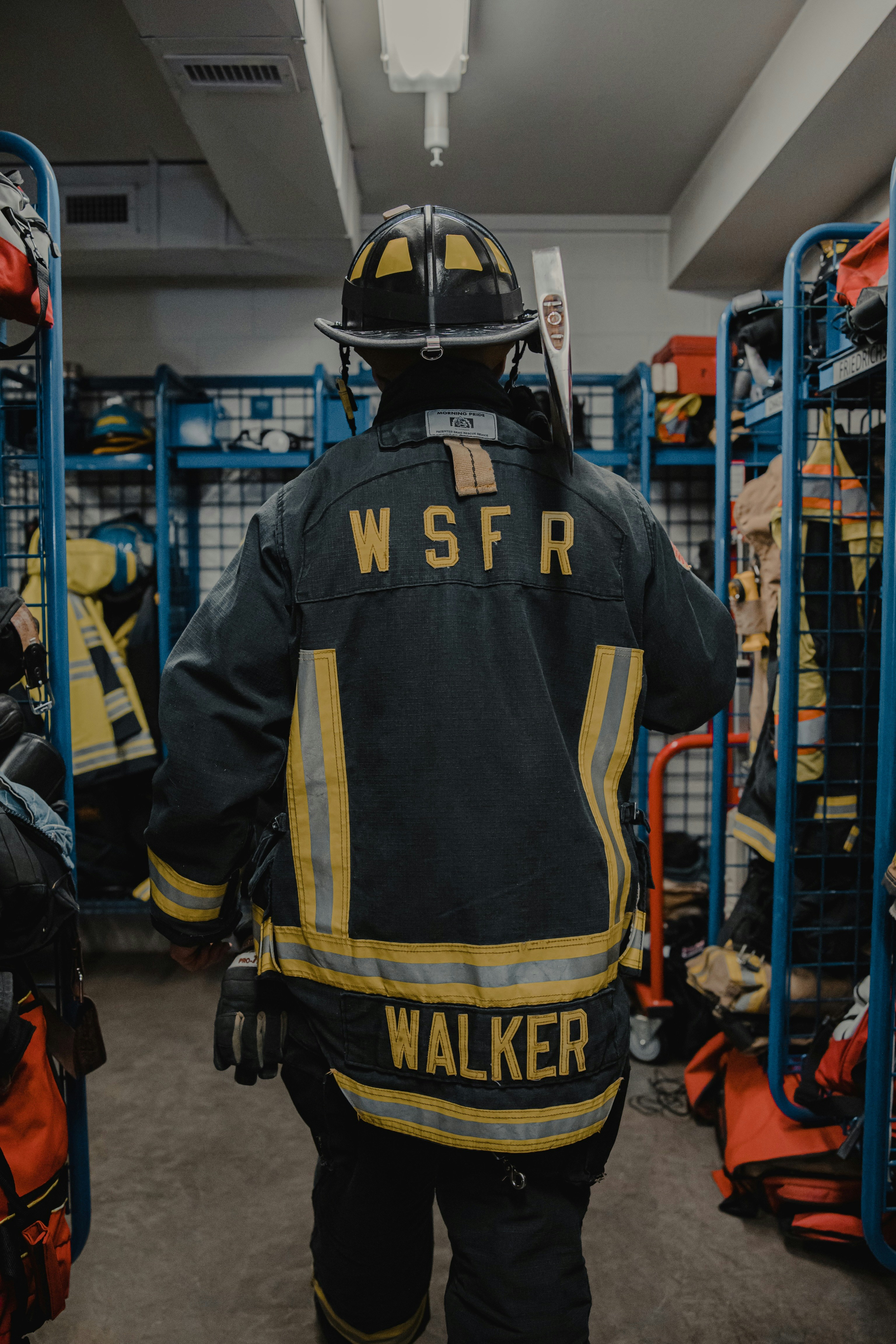 Backlit Hero: A Firefighter in the Quiet Wardrobe Hallway