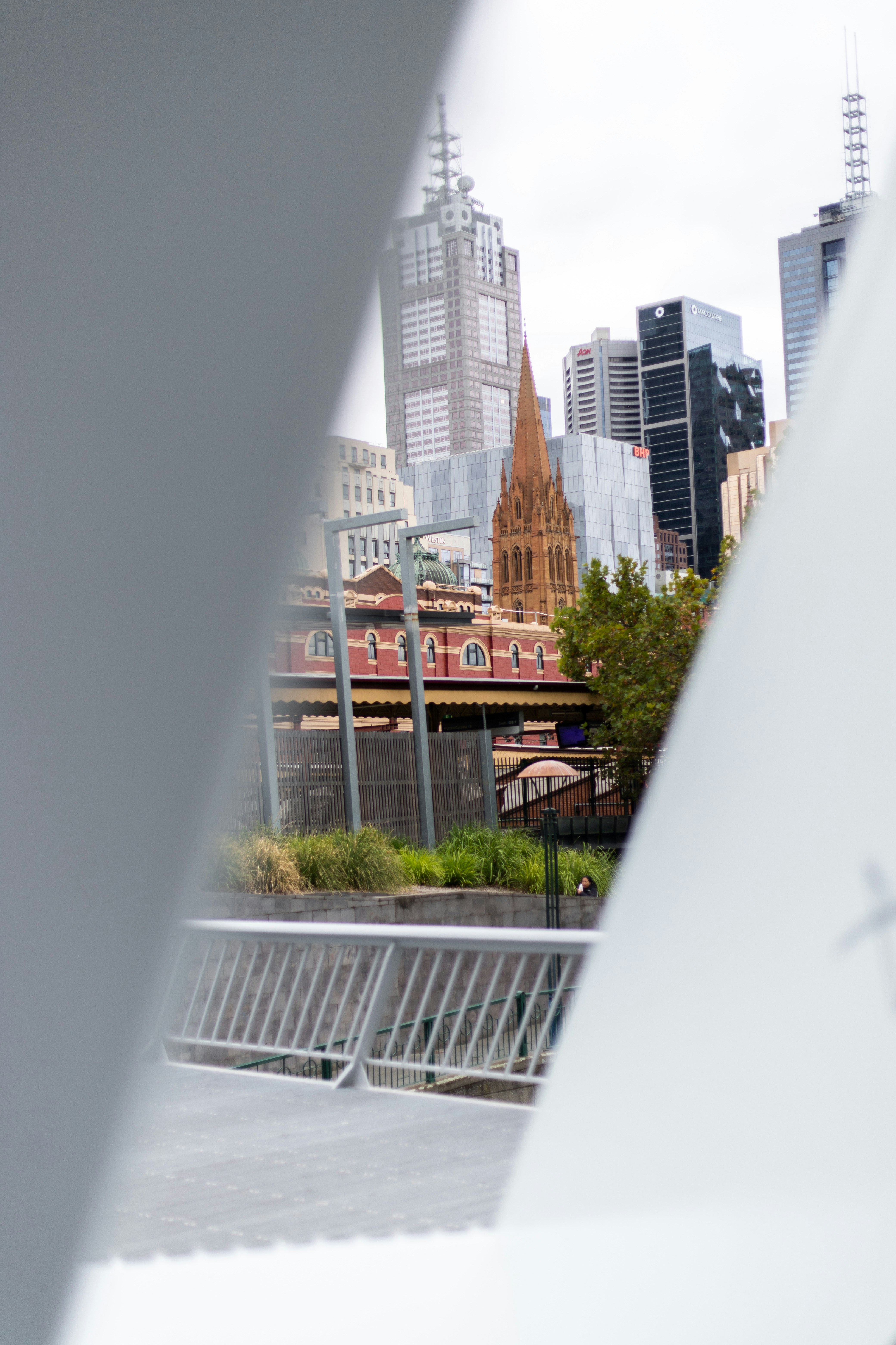 white metal fence near brown concrete building during daytime