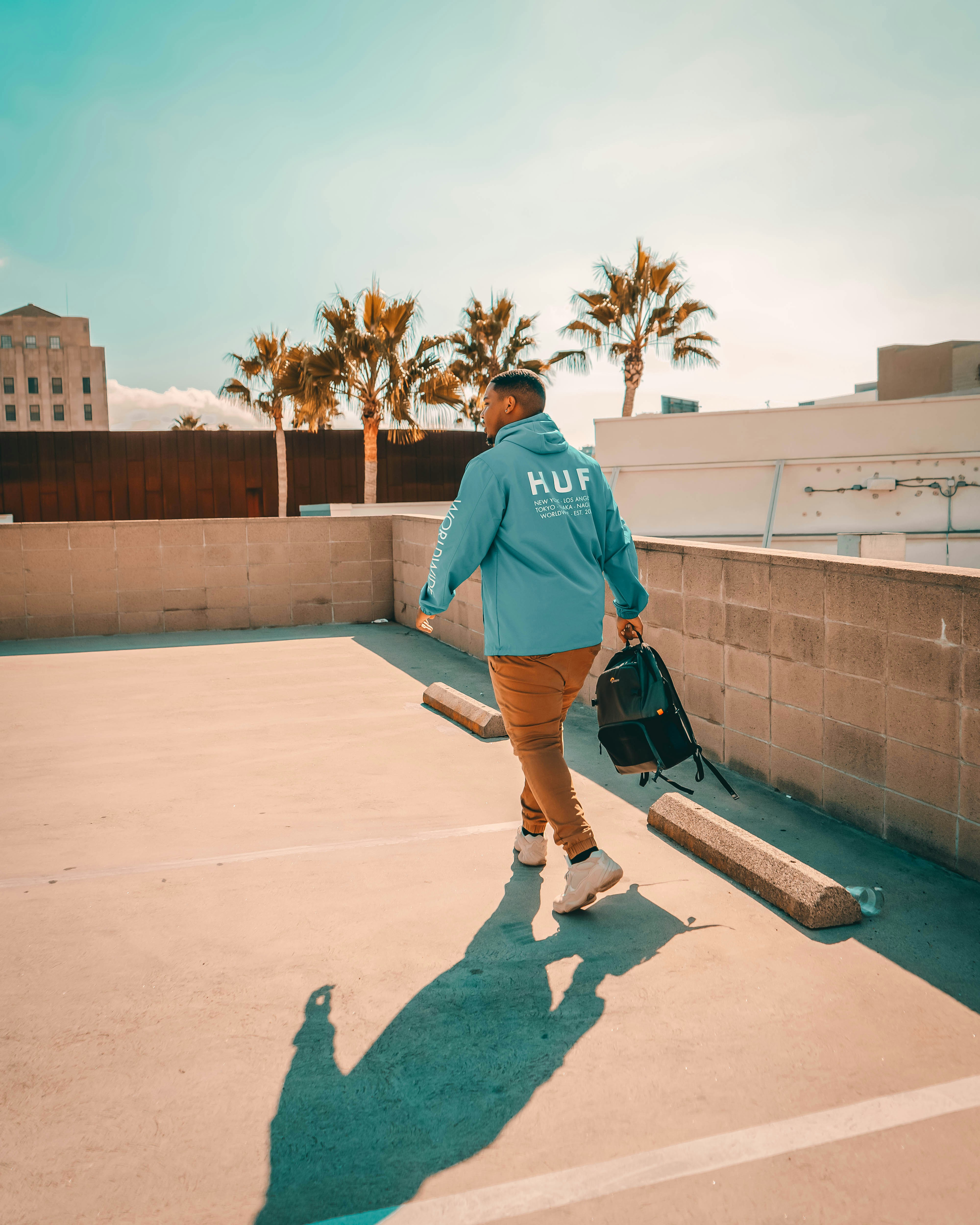 Runner in a Turquoise Hoodie on a Rooftop Walk
