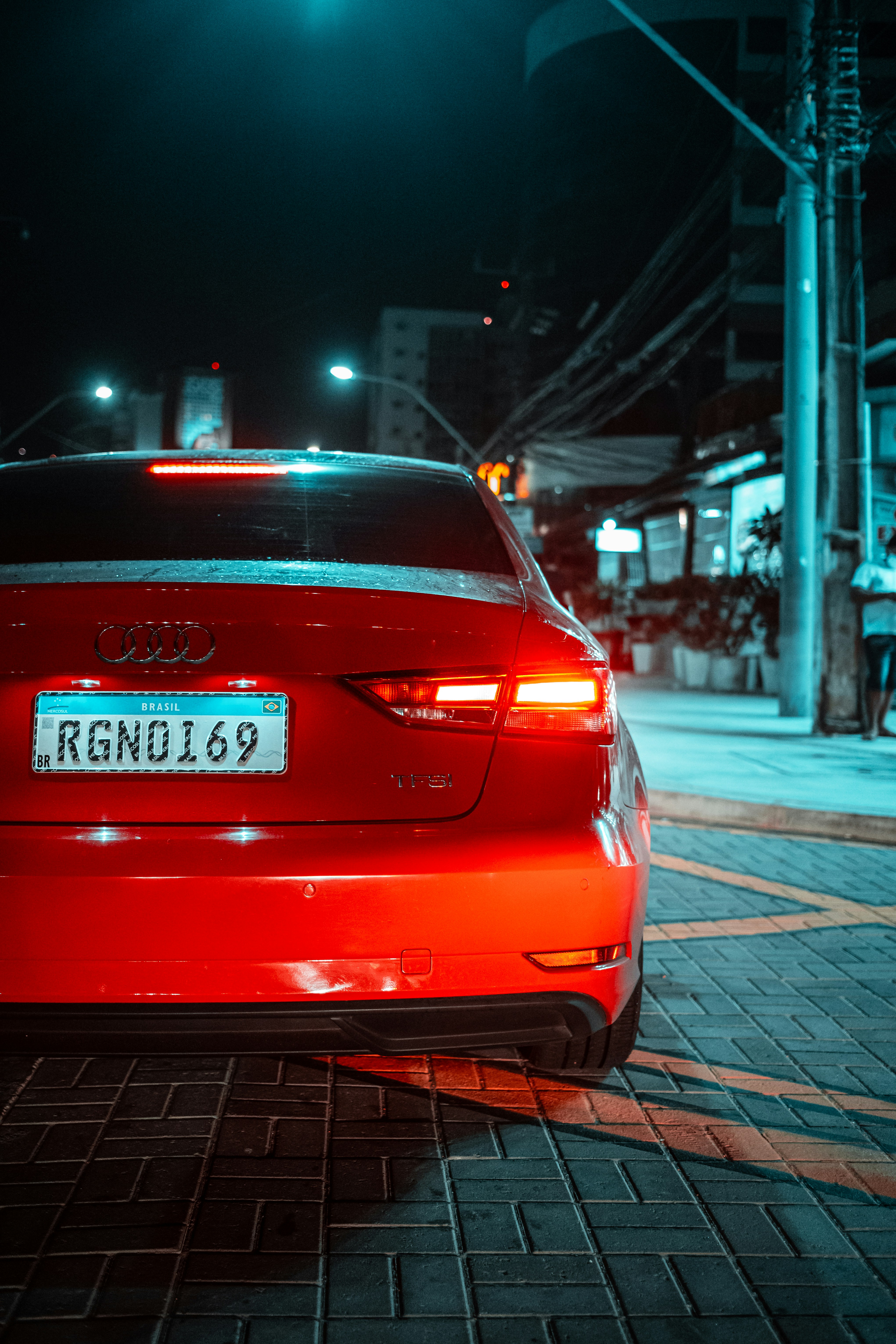 Neon-Blue Night, Red Audi: Quiet Street After Hours