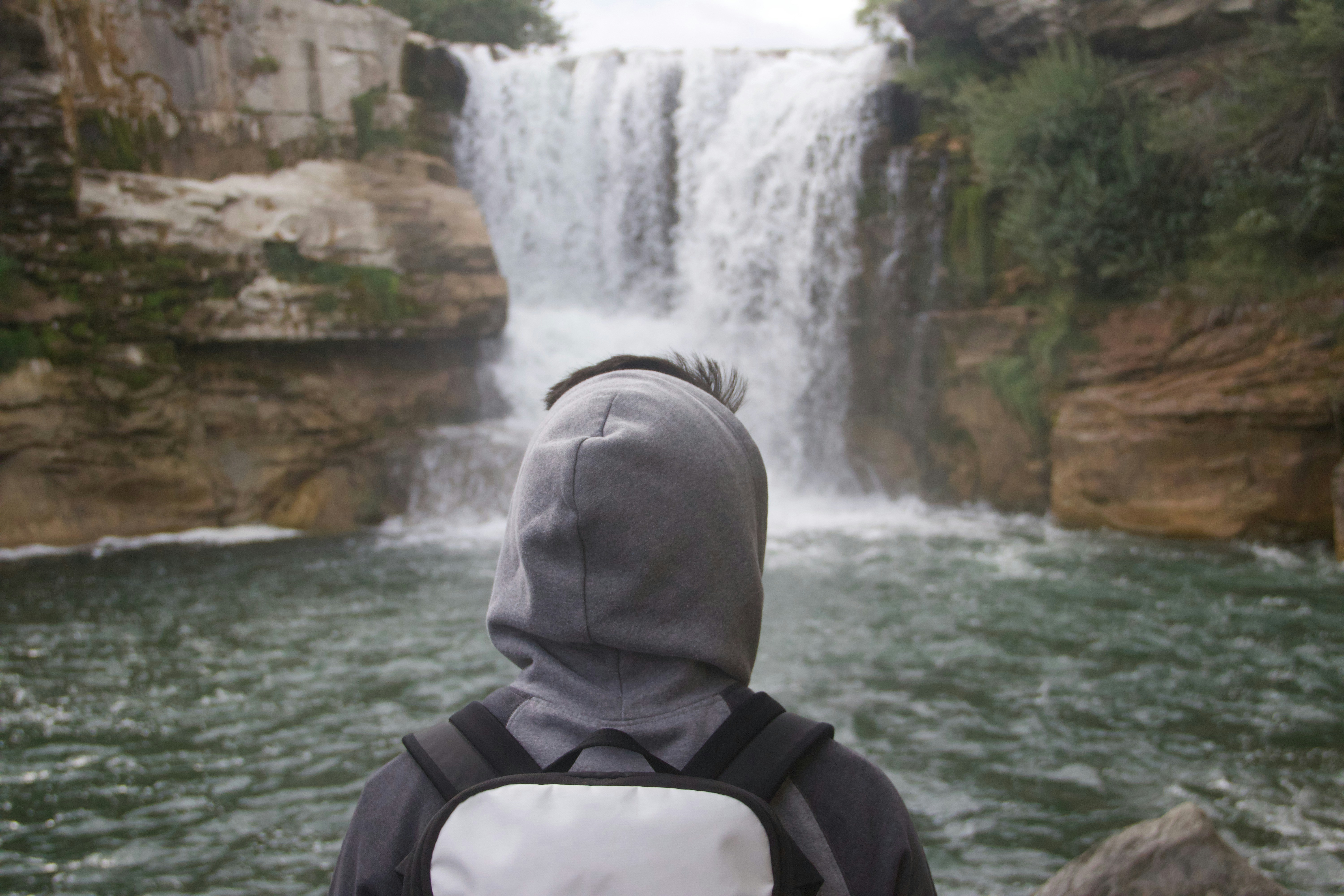 Traveler in the Shadow of a Cascade