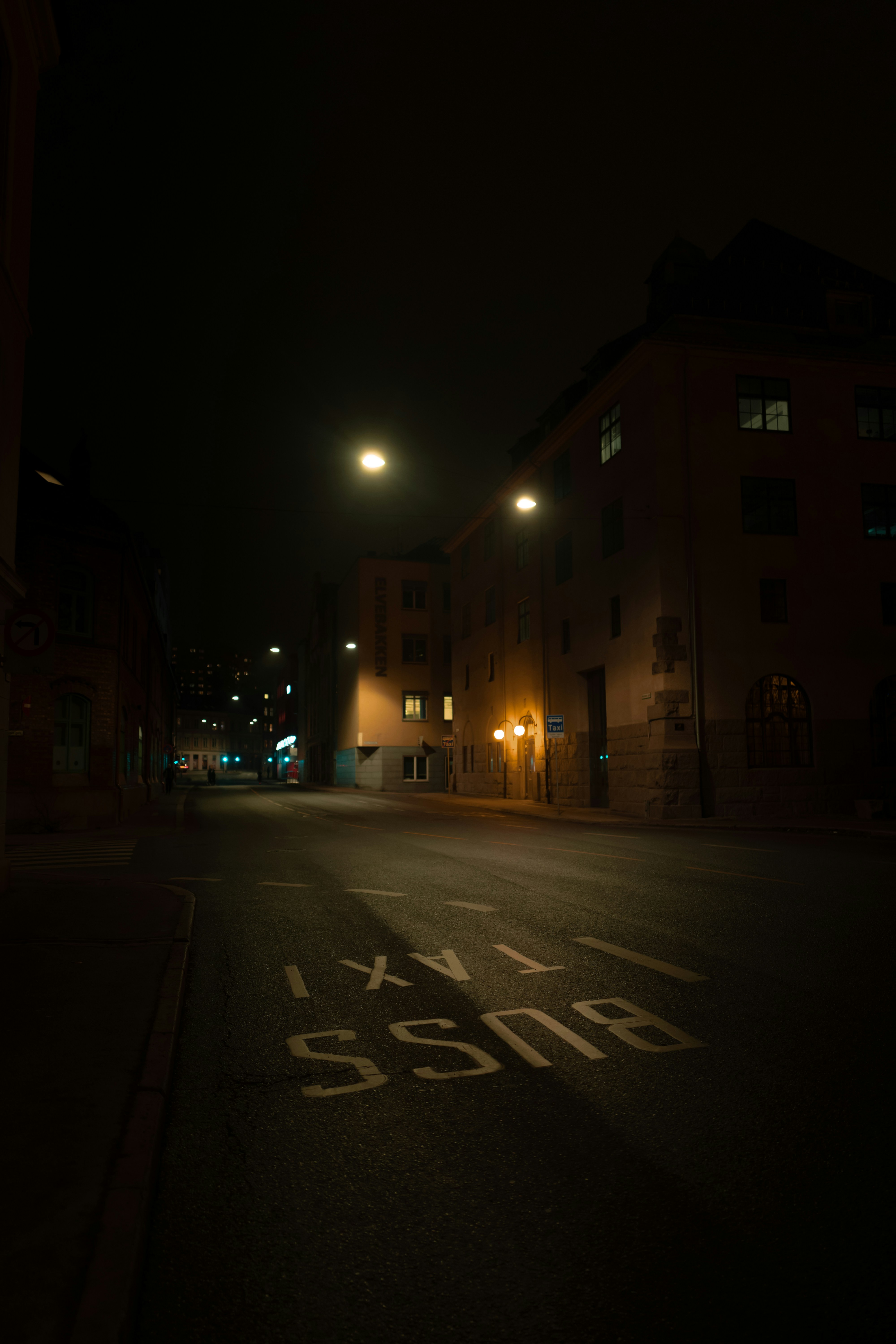 Amber Streetlamps Illuminate a Quiet City Street at Night