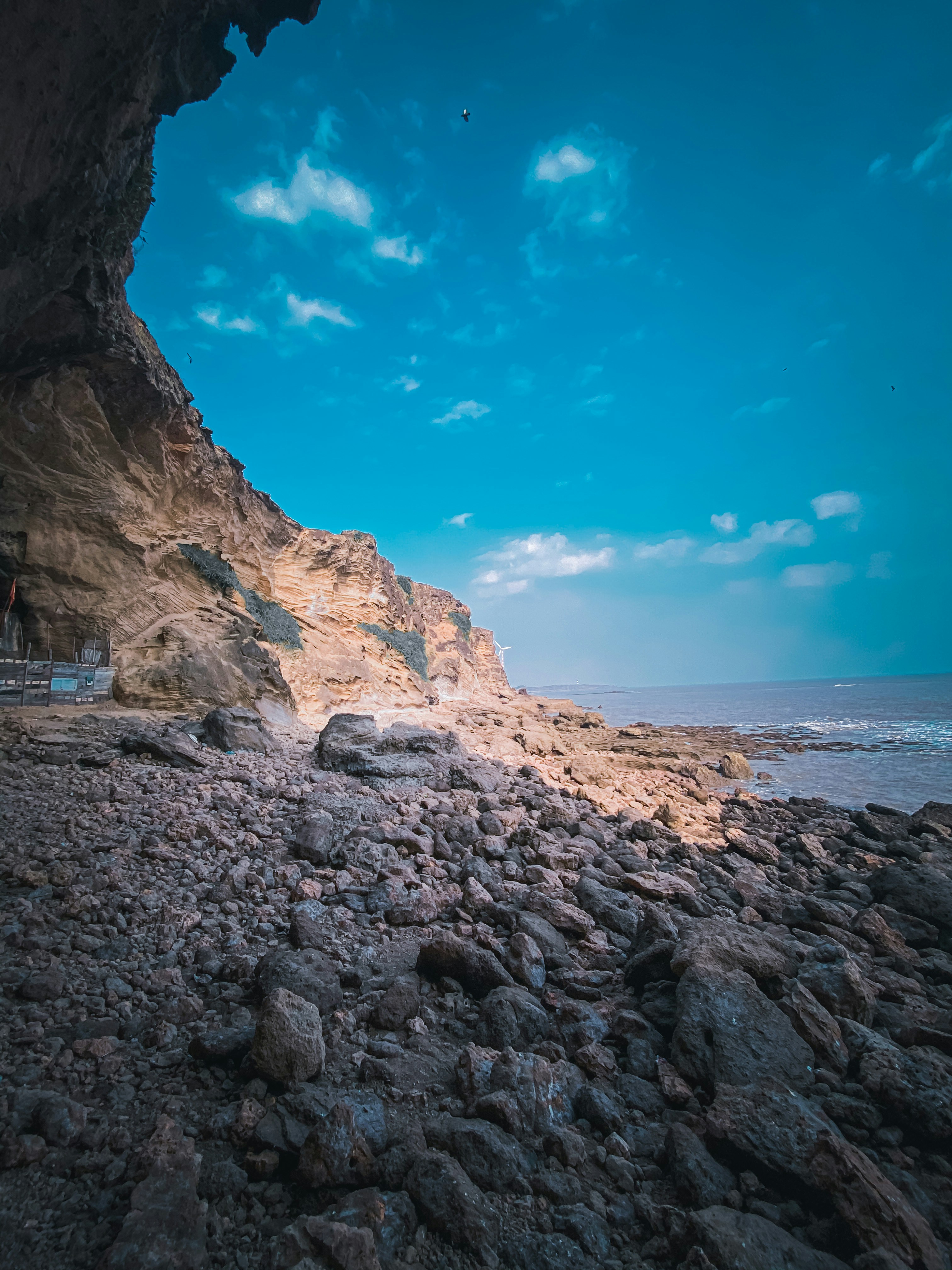 brown rock formation near body of water during daytime
