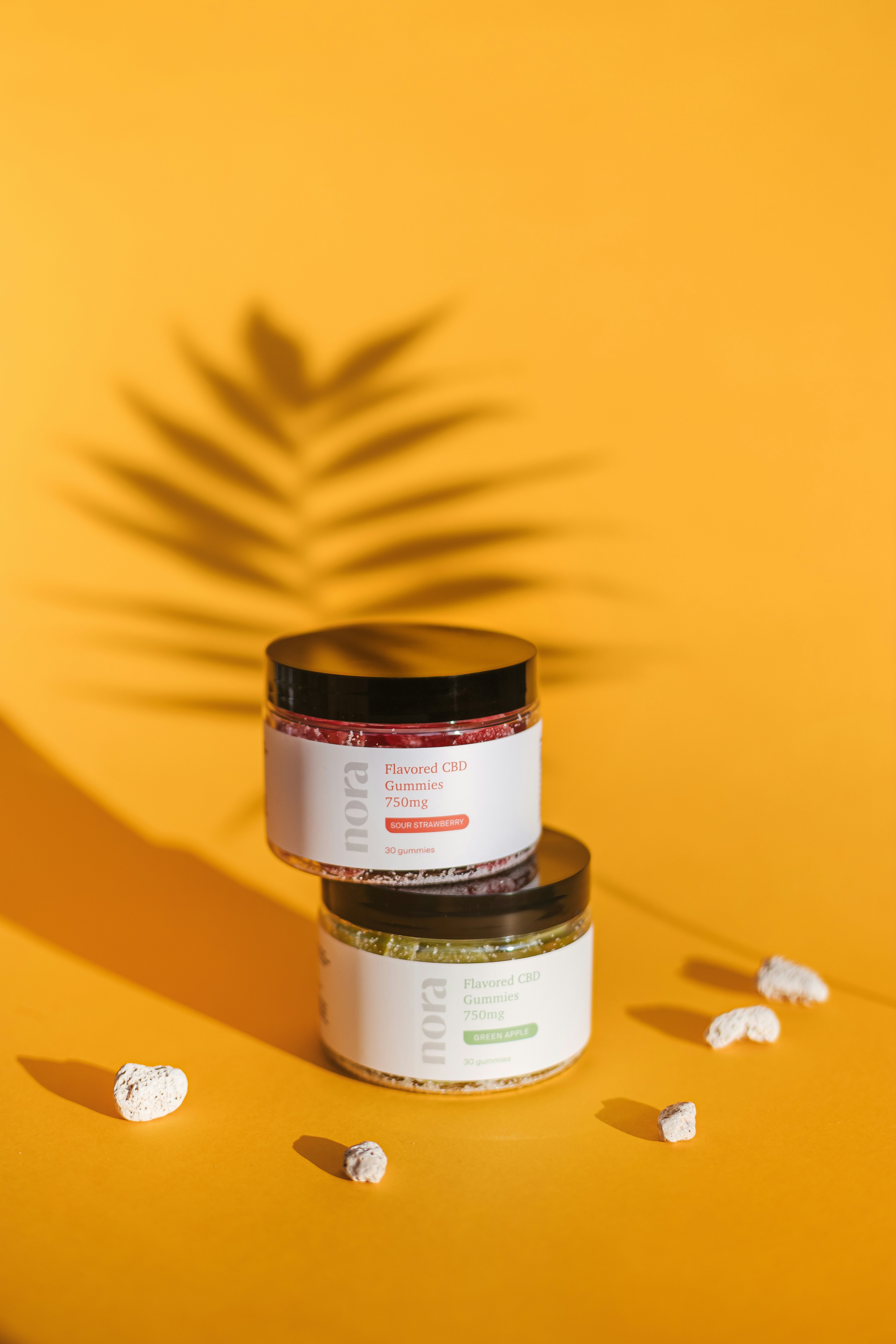 Palm-Shadowed CBD Jars on a Bold Orange Studio Backdrop