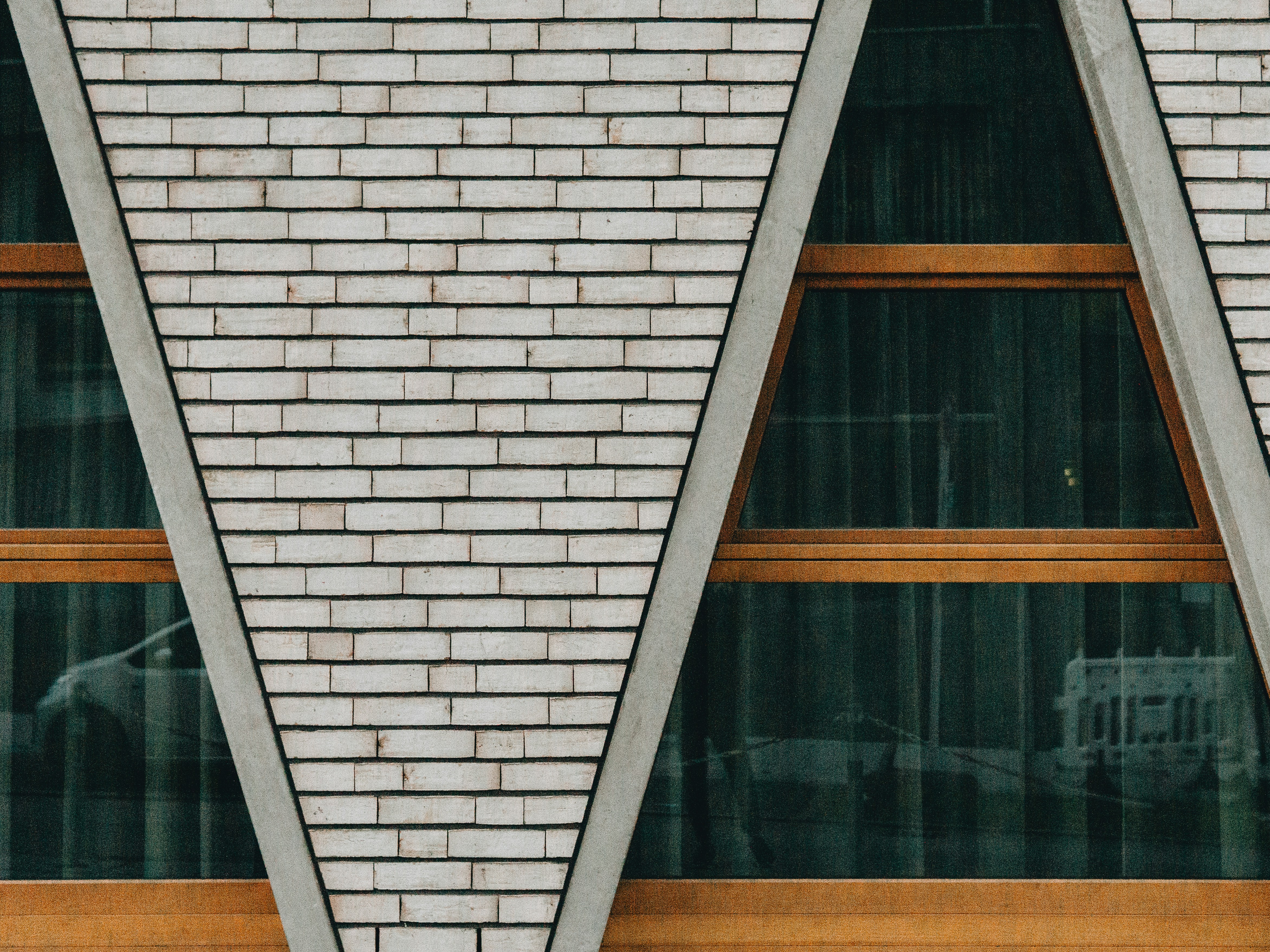 V-Shaped Facade: Quiet Geometry of Brick, Wood, and Glass