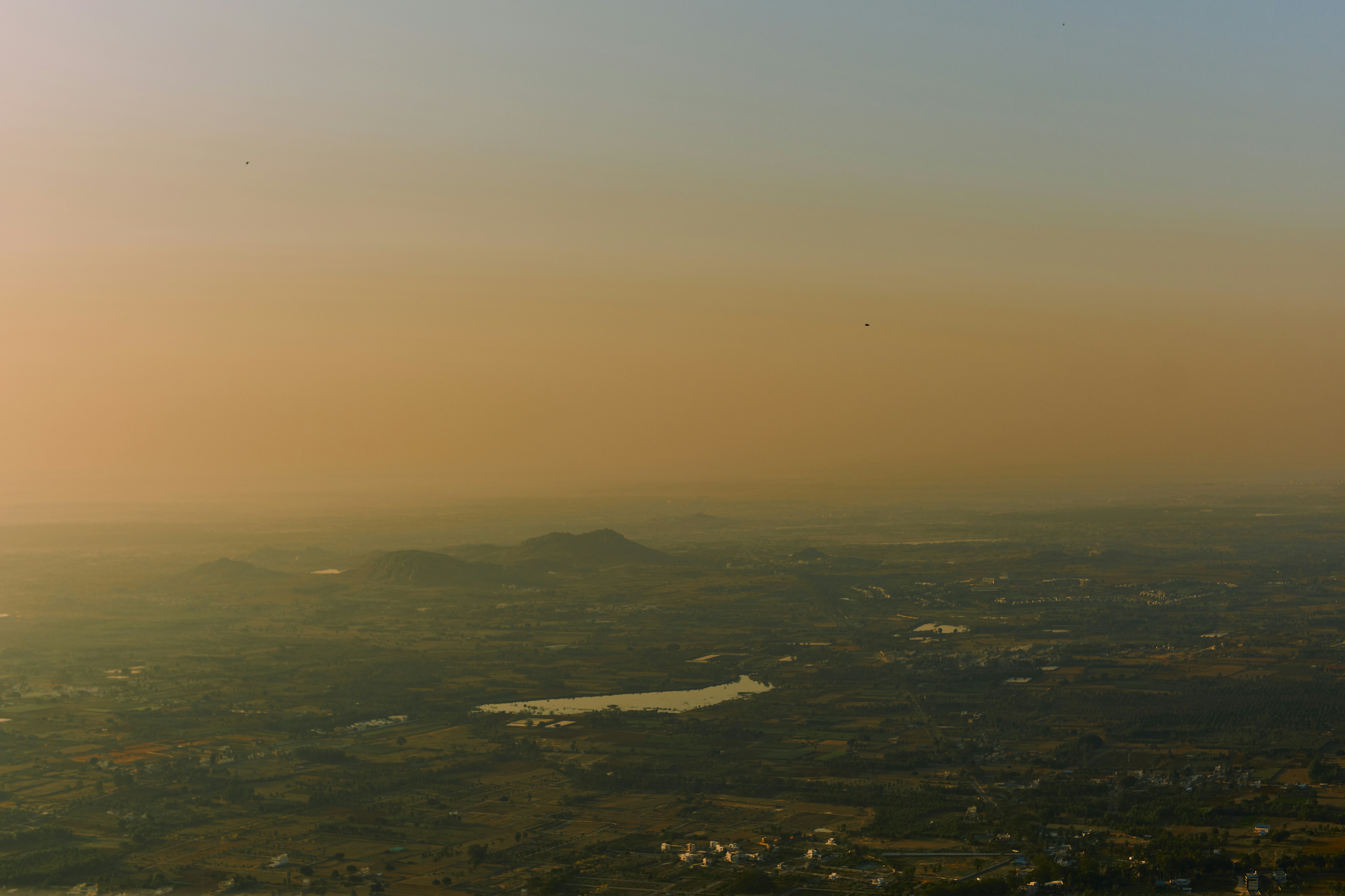 Amber Horizon Over a Quiet Inland Lake: Aerial Patchwork at Dusk