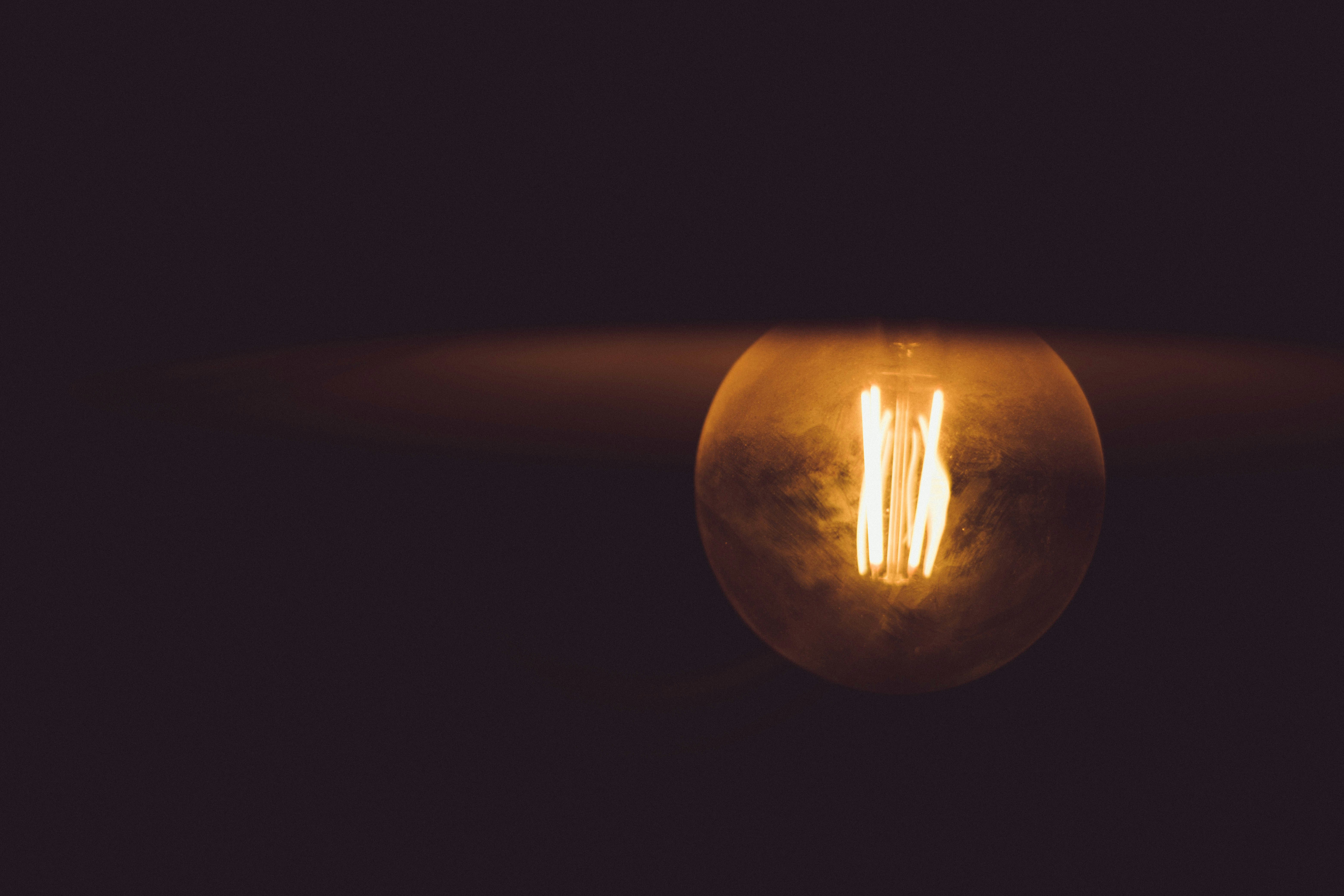 Low-Light Ember: A solitary filament glows within velvet darkness.