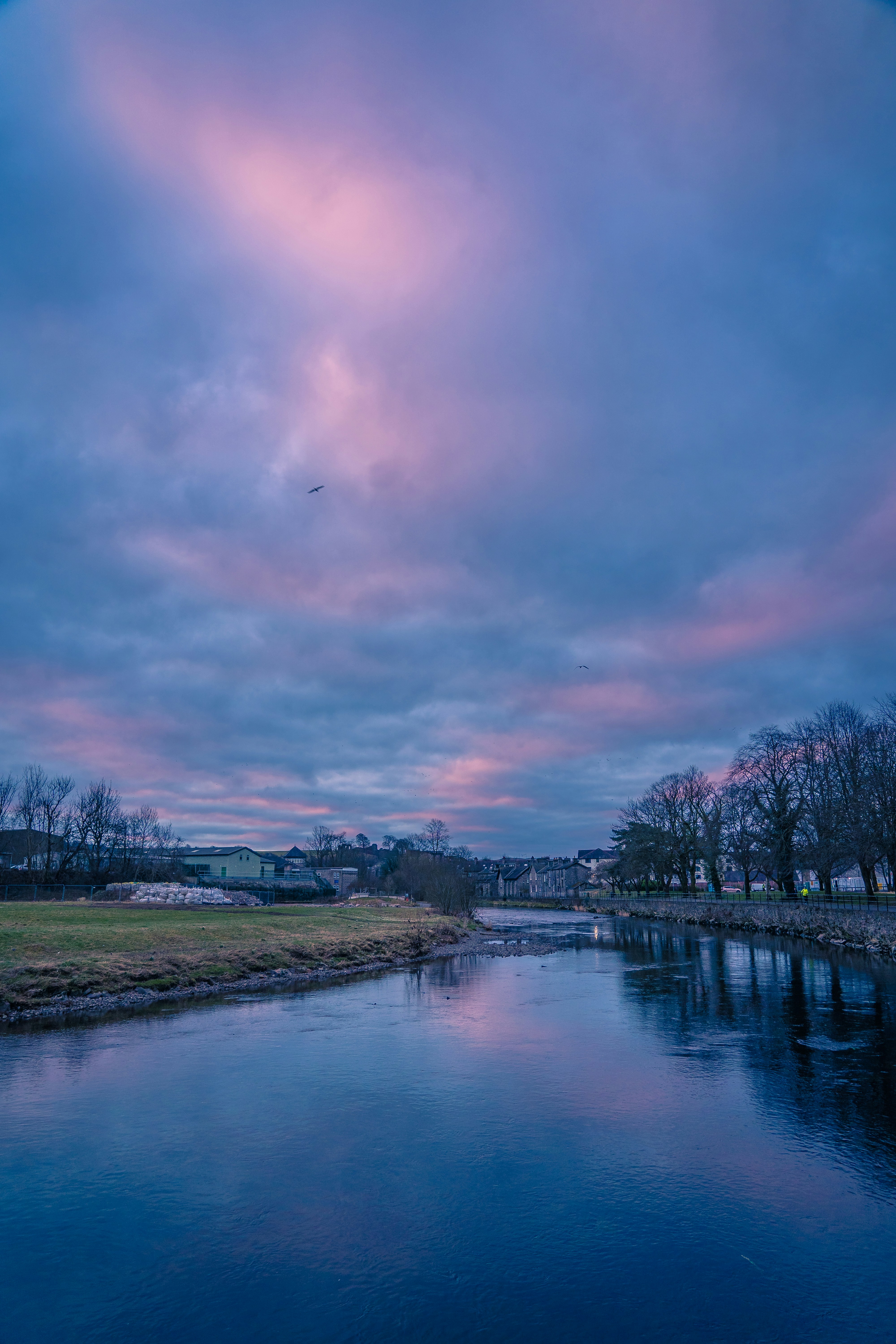 Pastel Sky Over a Tranquil River Bend at Dusk