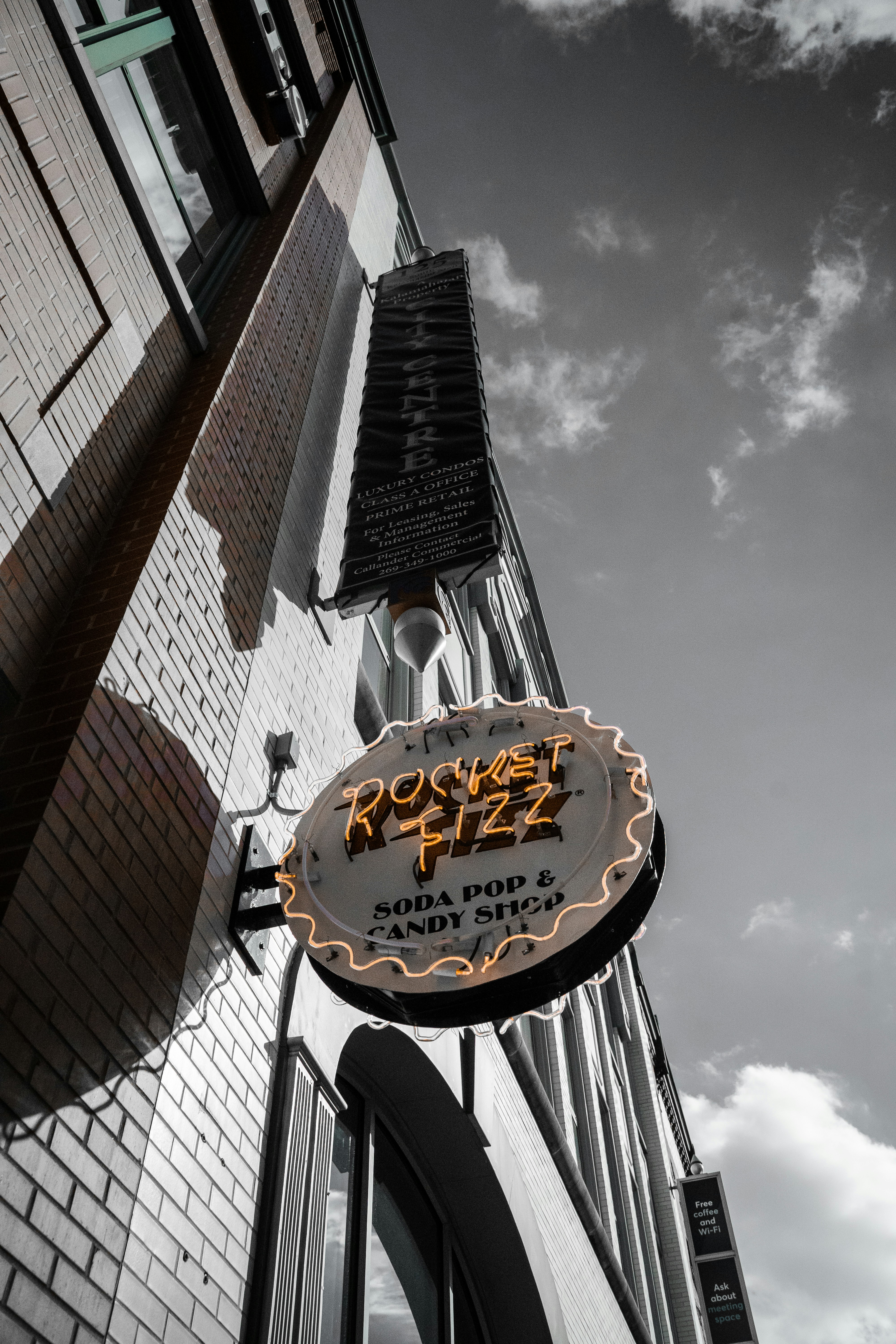 Neon Orb on Brick: The Rocket Fizz Sign Reaches Toward the Sky