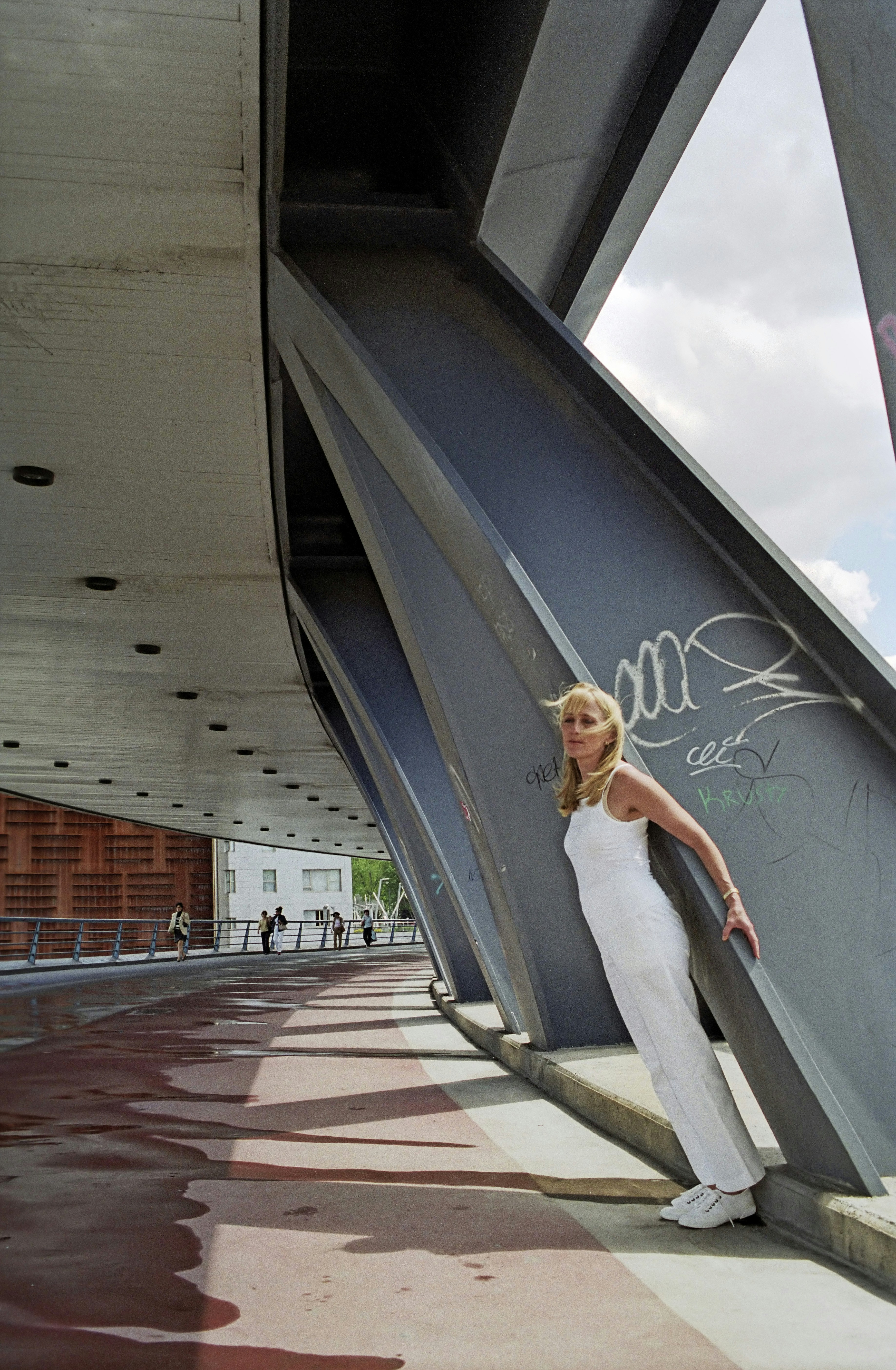 Steel Arches and White Dress: A Portrait Under Urban Canvases