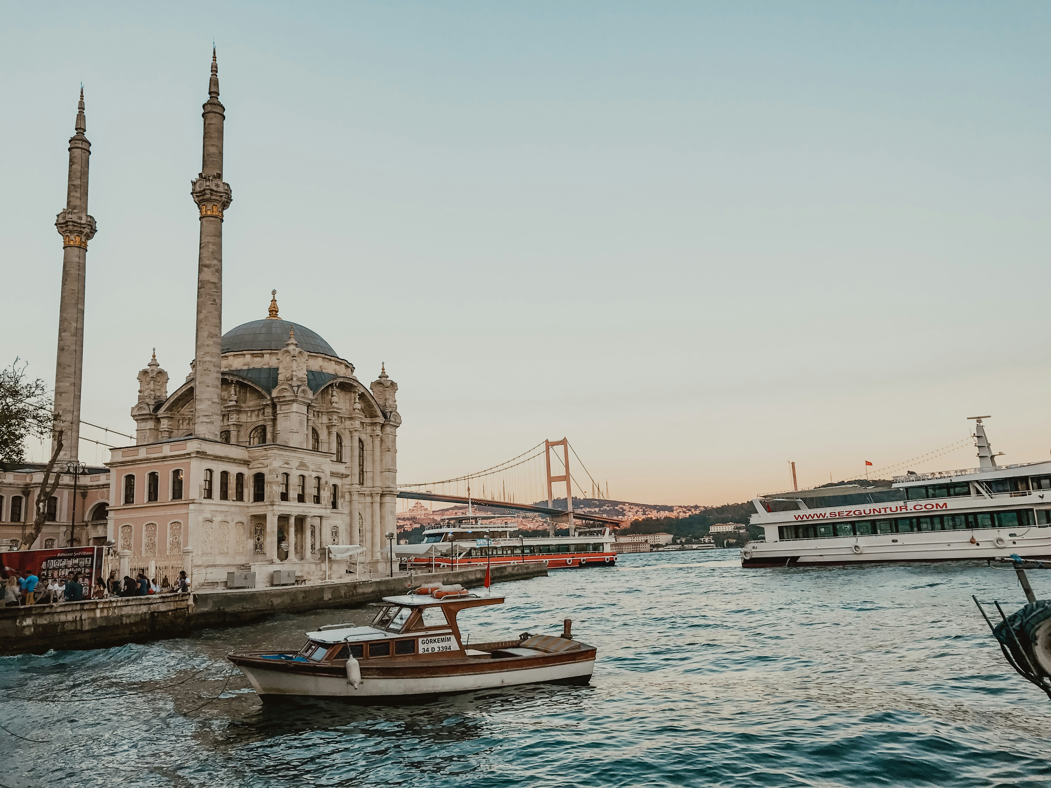 A boat in the water near a large building photo – Free Turkey Image on ...