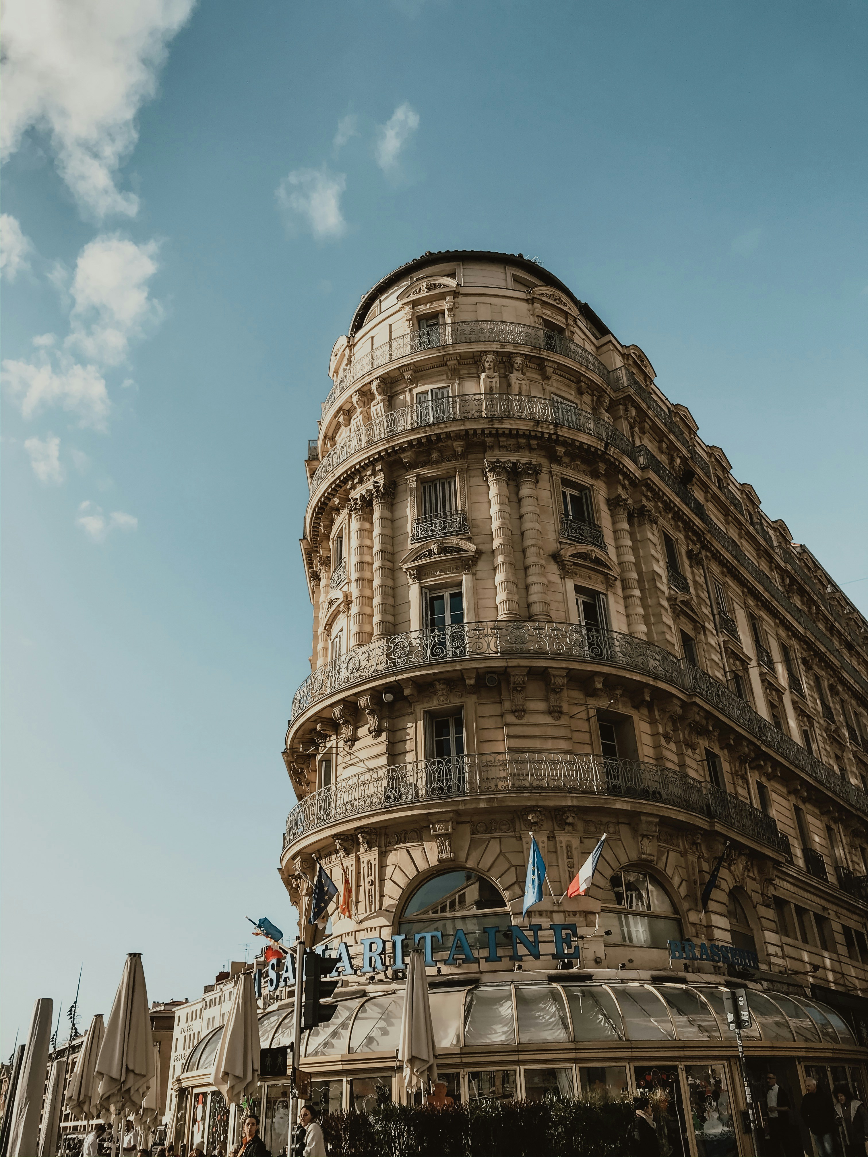 Historic building with intricate architectural details under a clear blue sky, showcasing the essence of Parisian style.