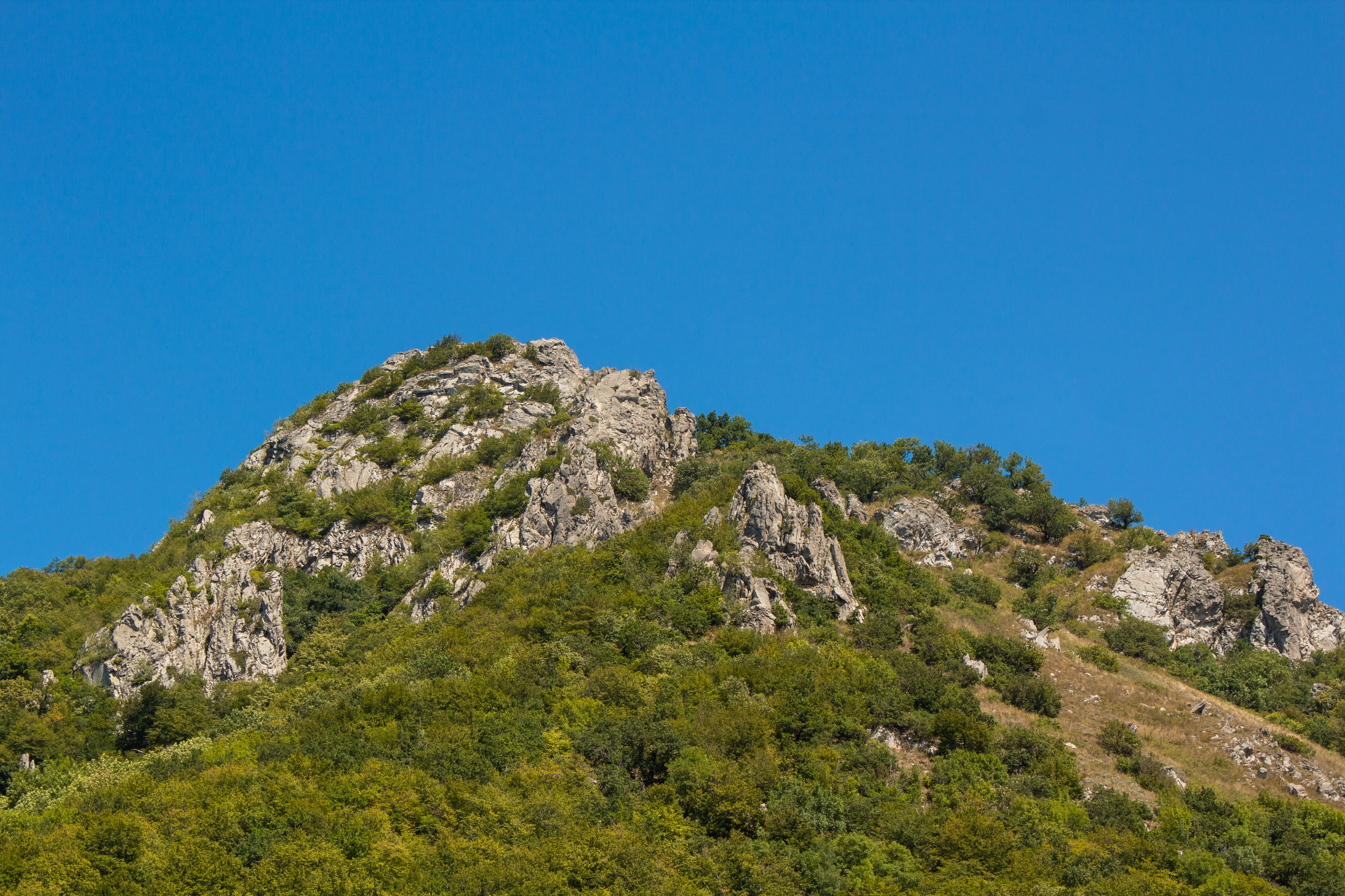 Green and gray rocky mountain under blue sky during daytime photo ...
