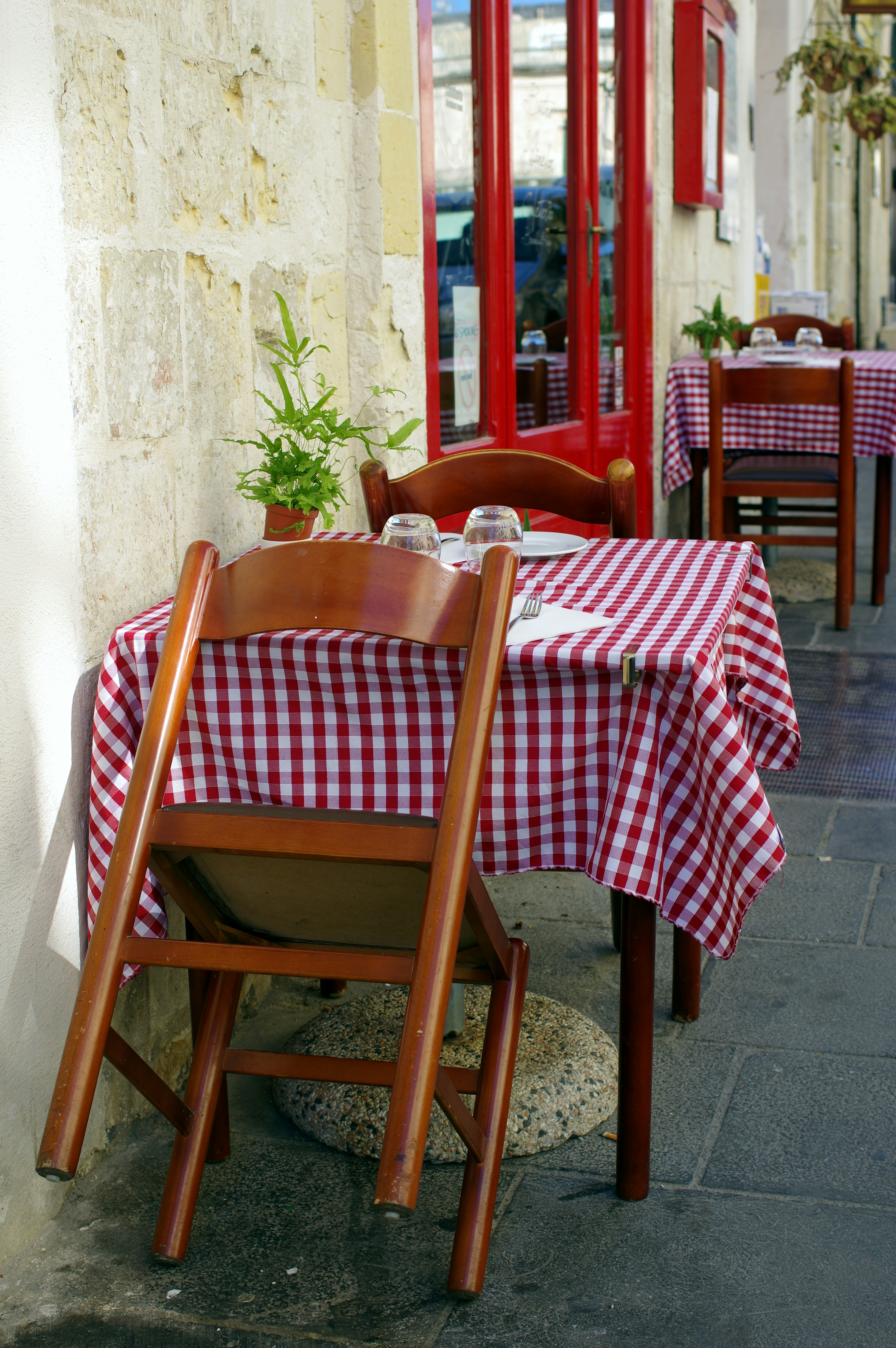 Red and white checked table cloth on brown wooden table photo – Free ...