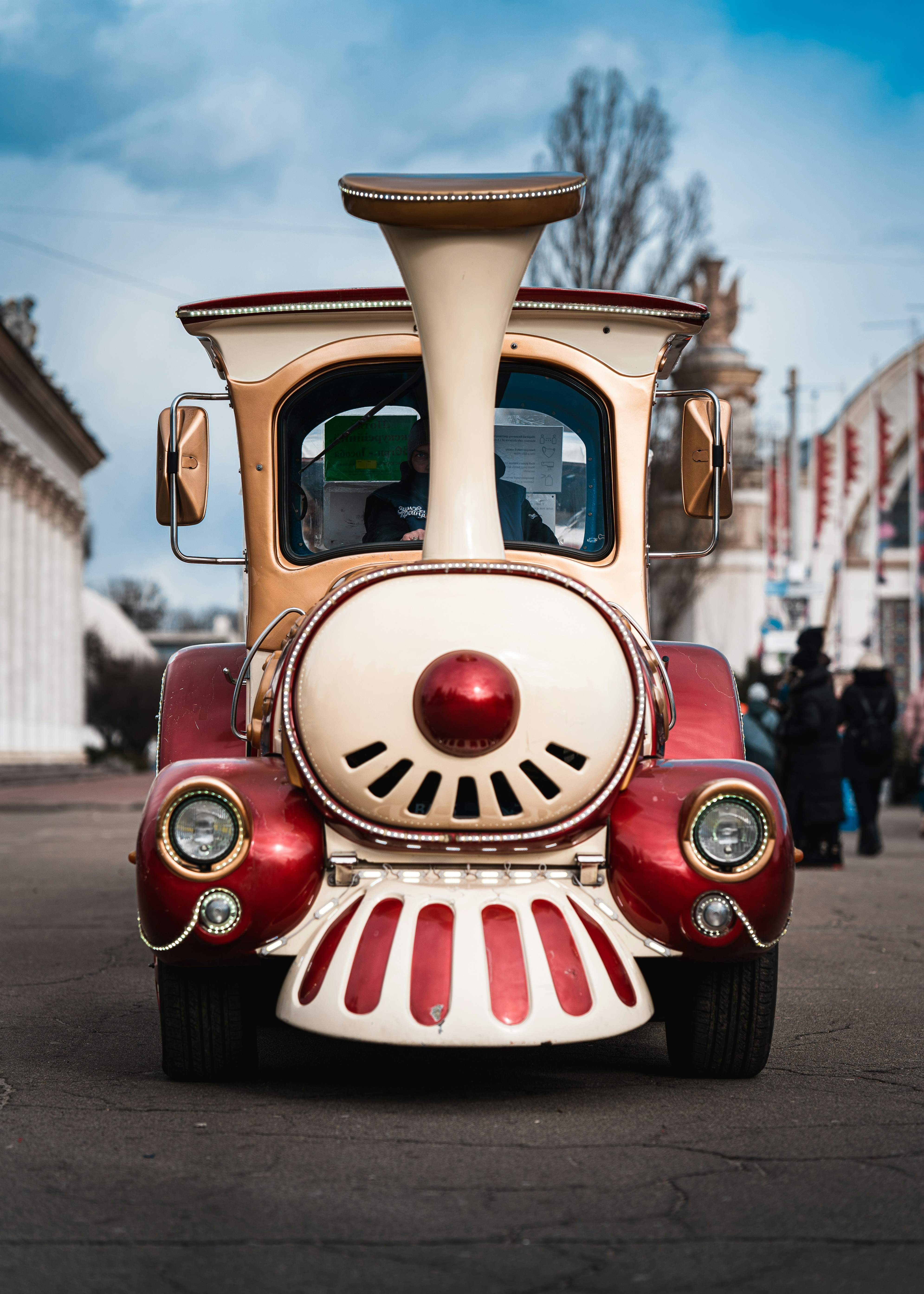 red and white vintage car on road during daytime