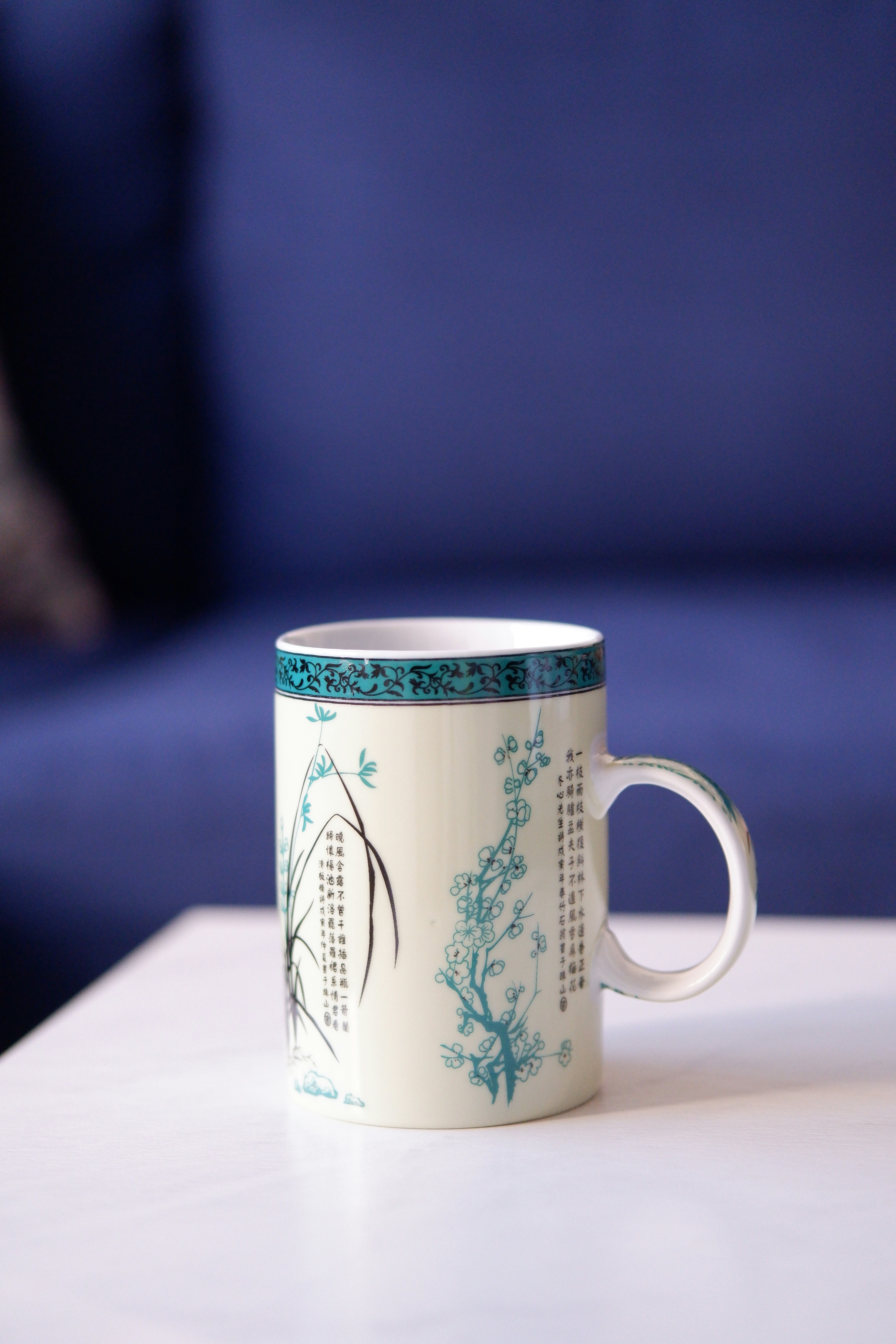 Teal-Rimmed Ceramic Mug on a Quiet Blue Backdrop