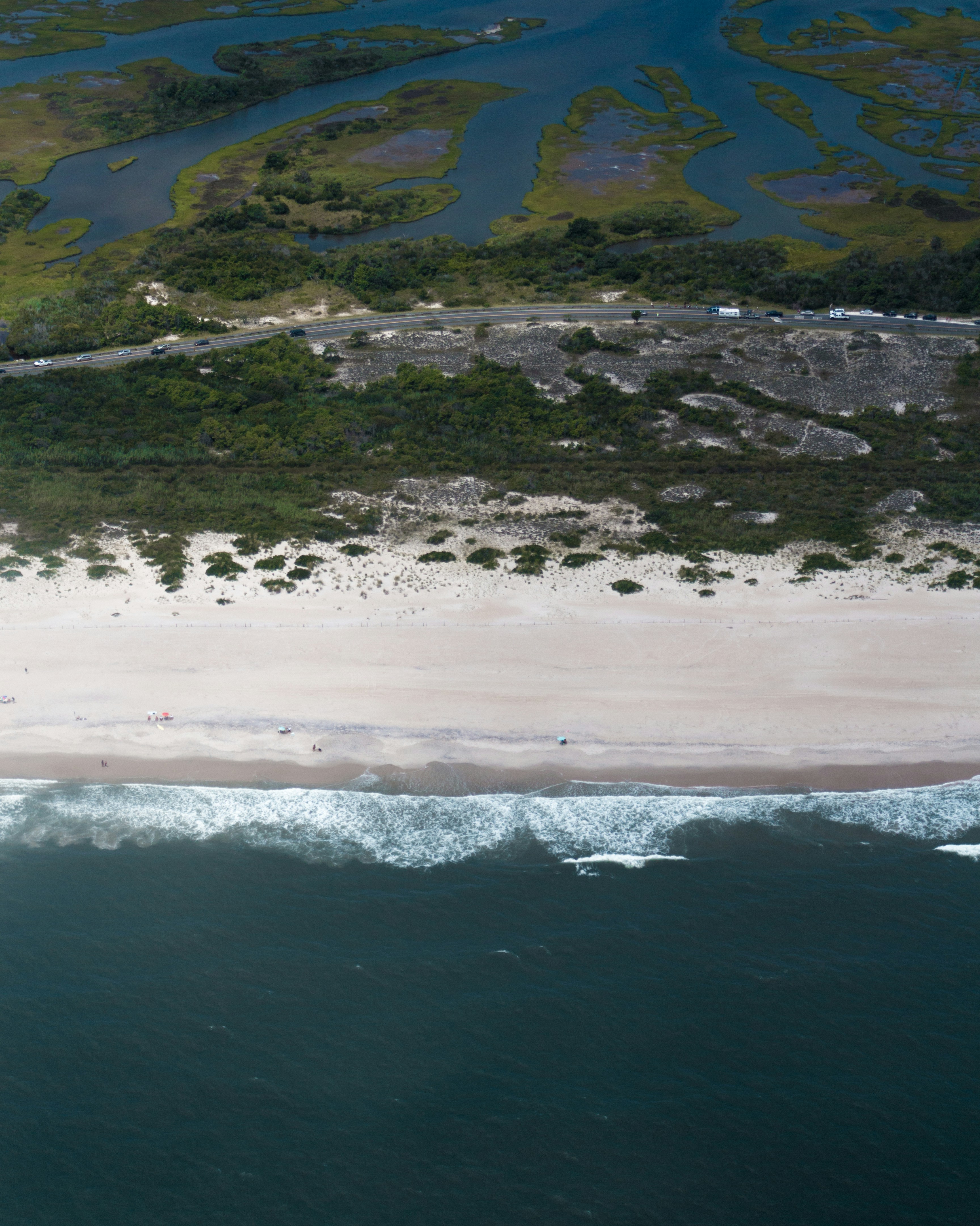 Dune Edge Highway: Aerial View of Beach, Road, and Marsh