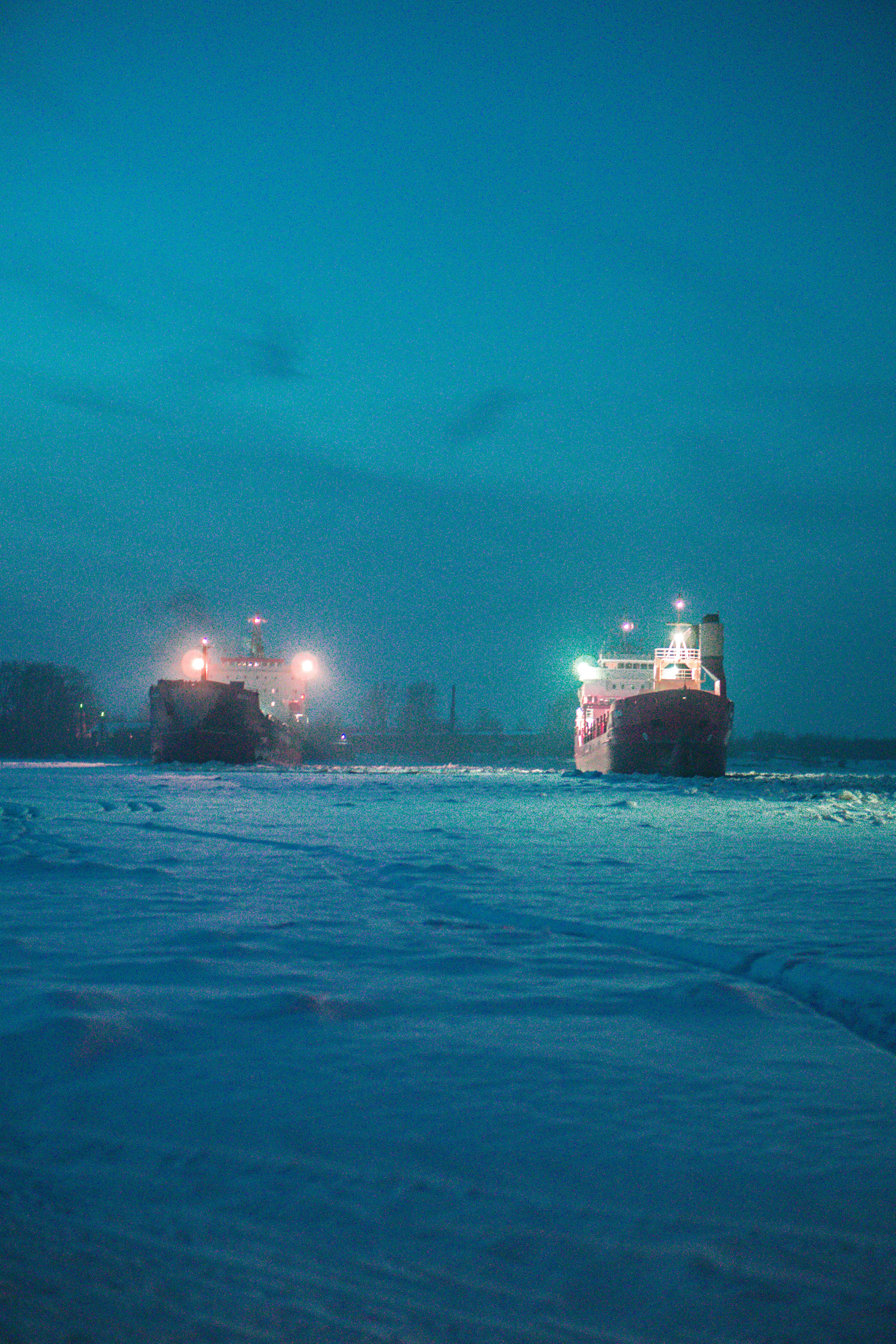 Icebound Luminescence: Twin Freighters Under a Blue Hour Sky