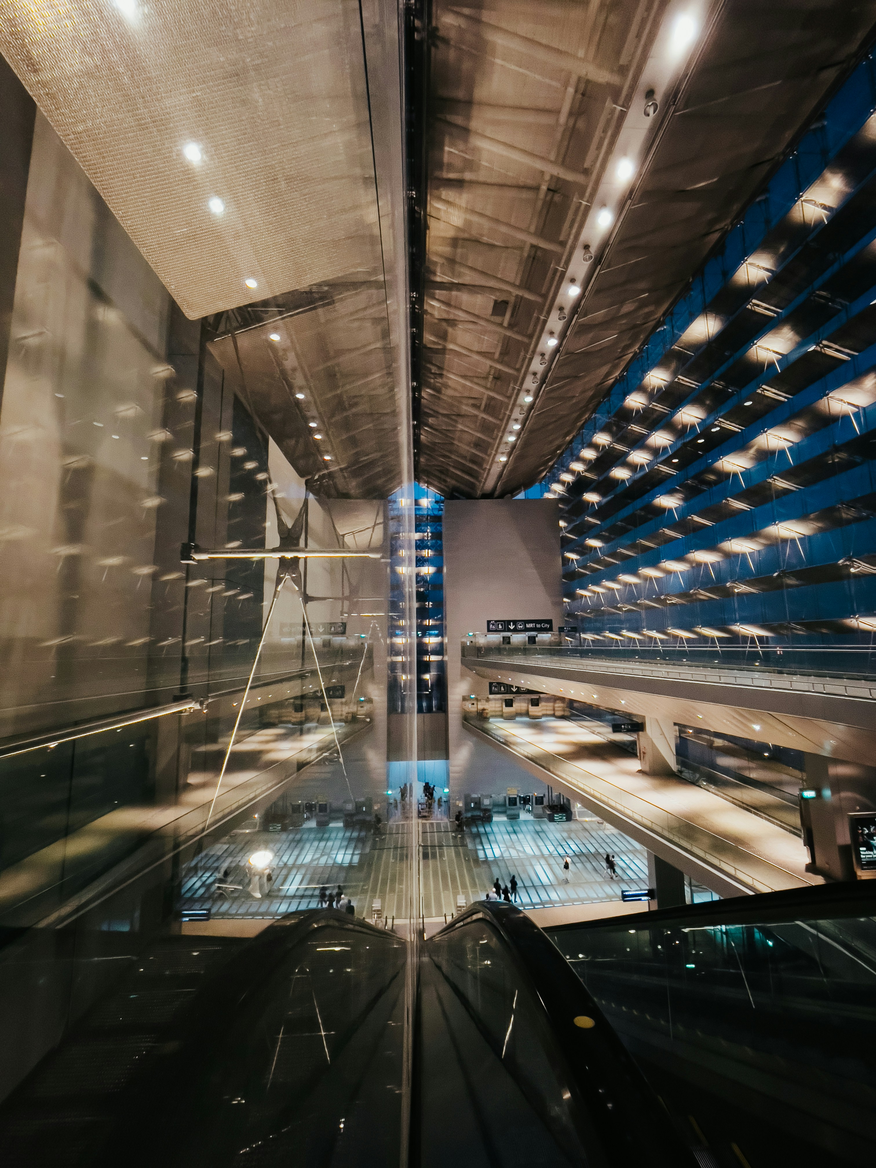 Vertical Atrium: Reflections and Escalators in a Modern Transit Hub