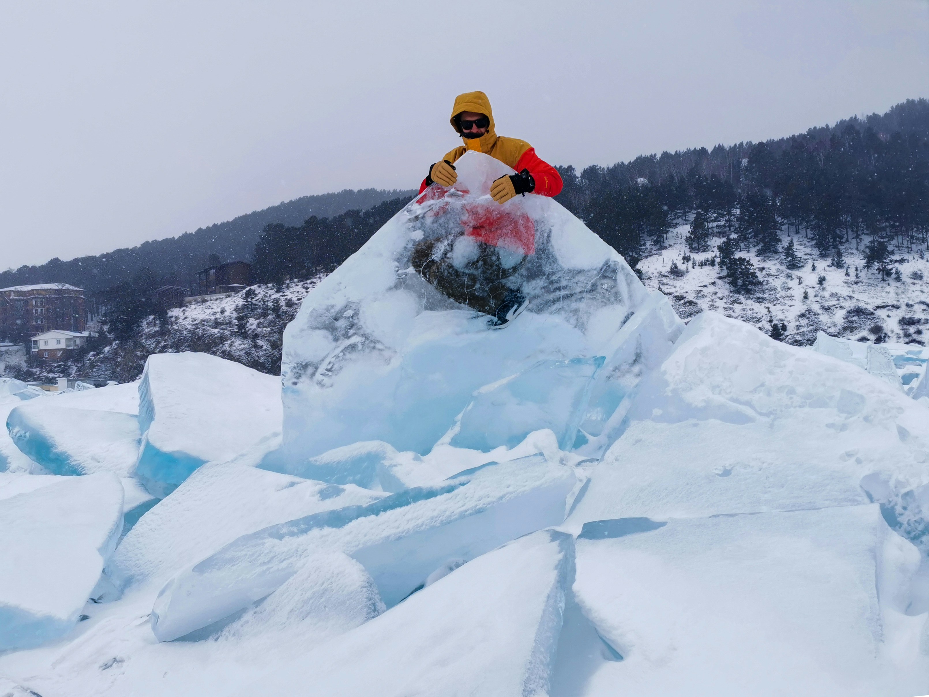 Ice Sculptor: climber perched on a crystal blue iceberg at dusk