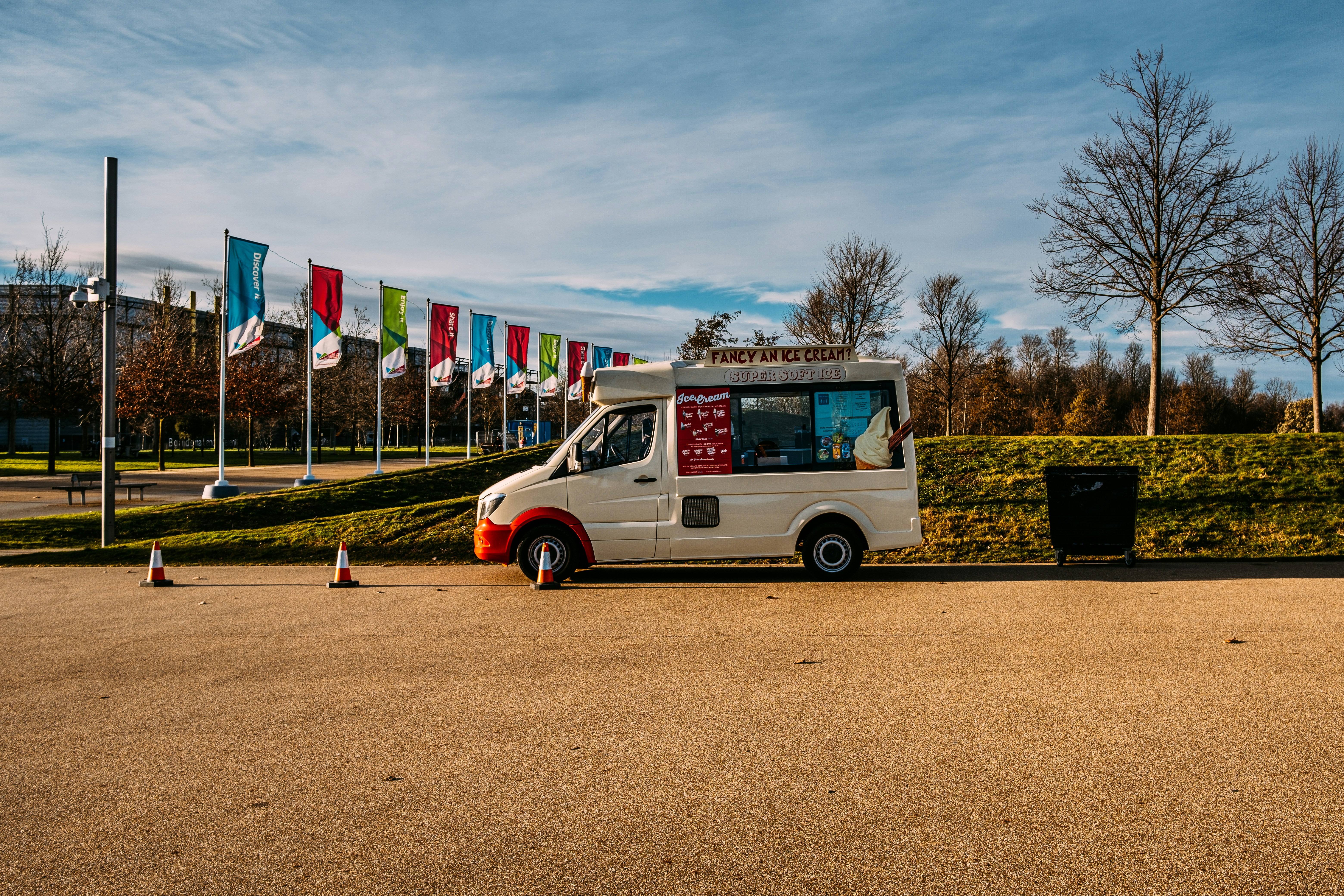 Ice-cream Van at Daybreak: Flags, Curved Road, and Open Sky