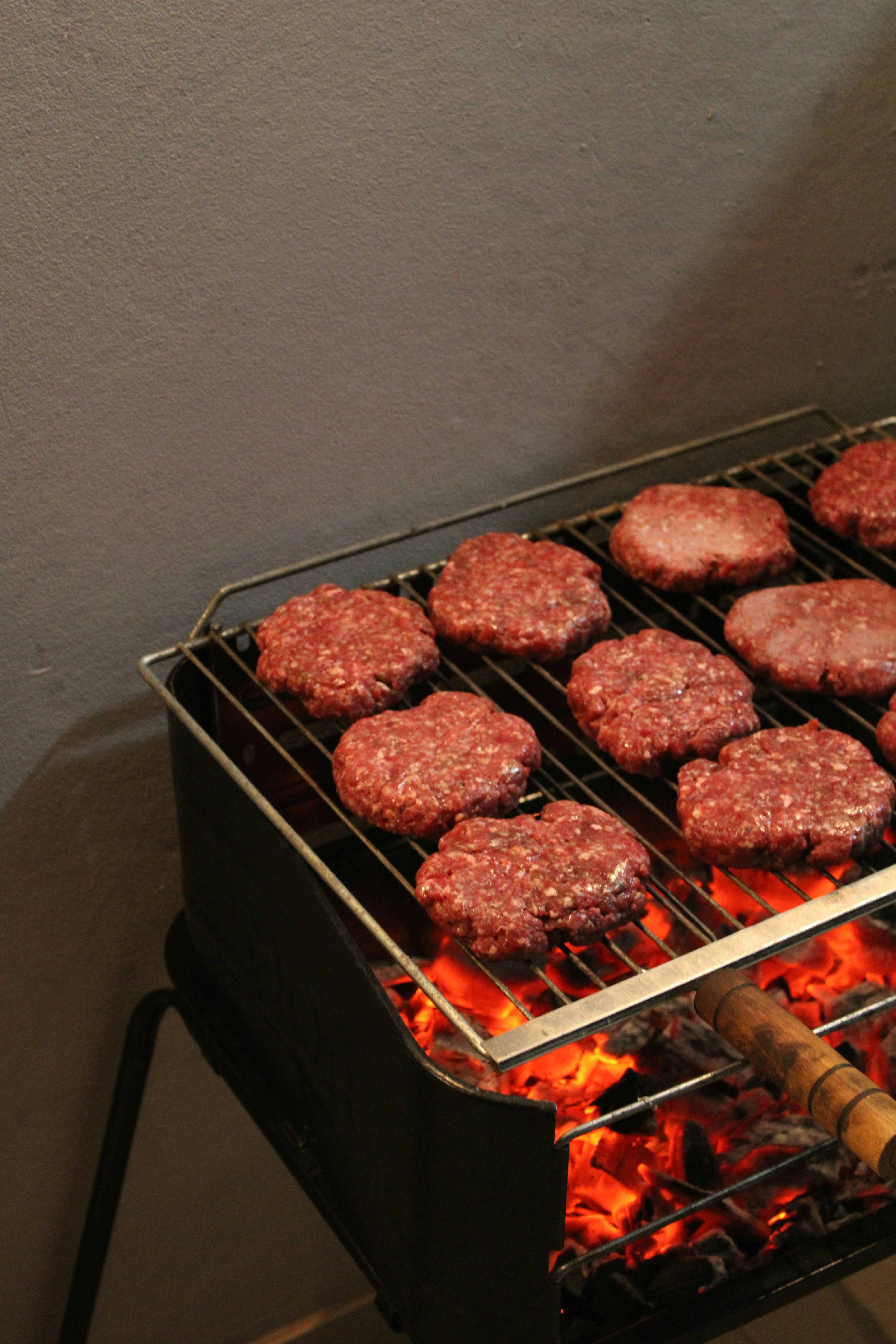 Ember-Glowing Patties on a Charcoal Grill: Close-Up of Backyard Barbecue