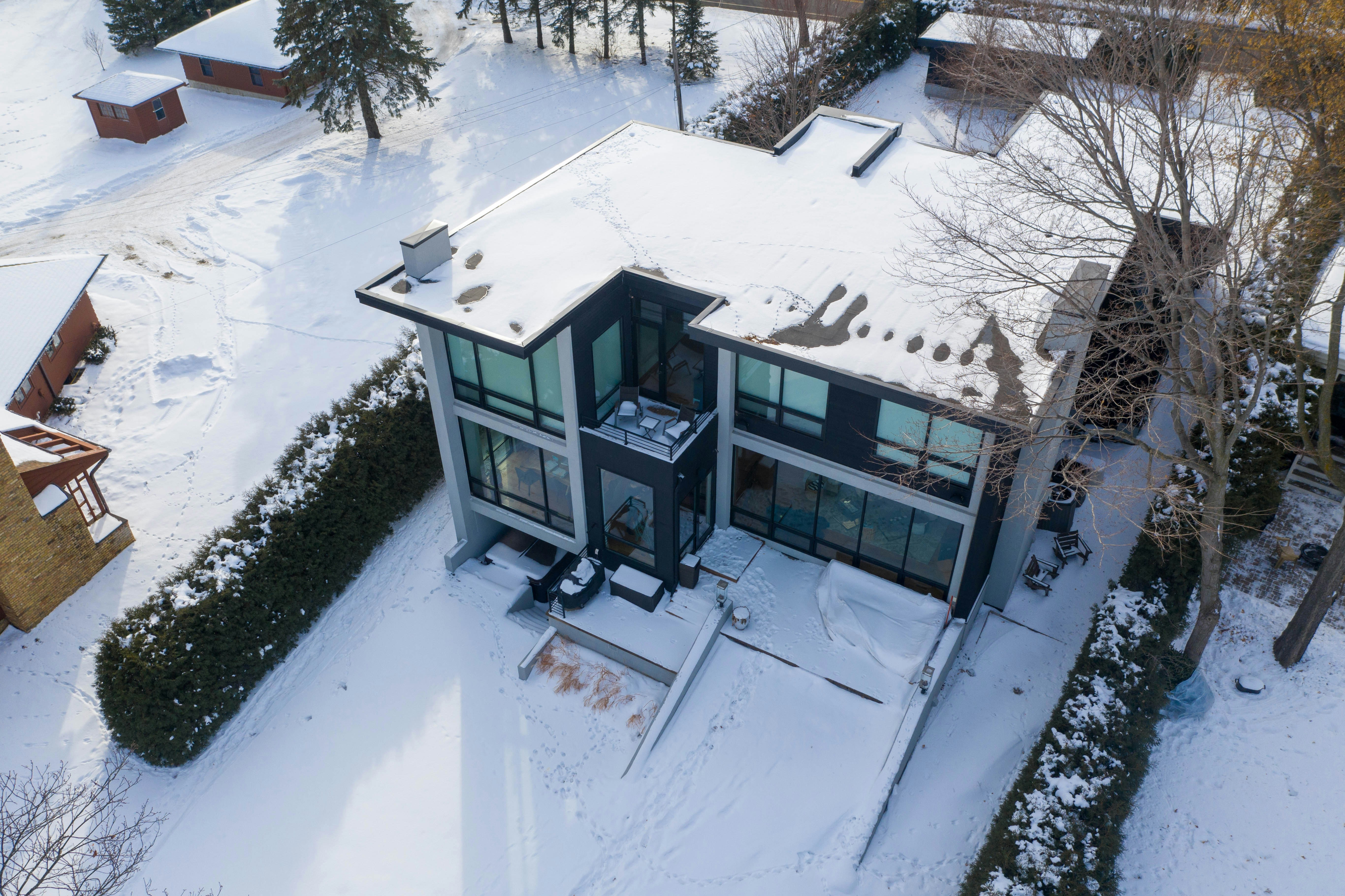 Snowbound Modern: Aerial Centerpiece of a Glass-Box Villa