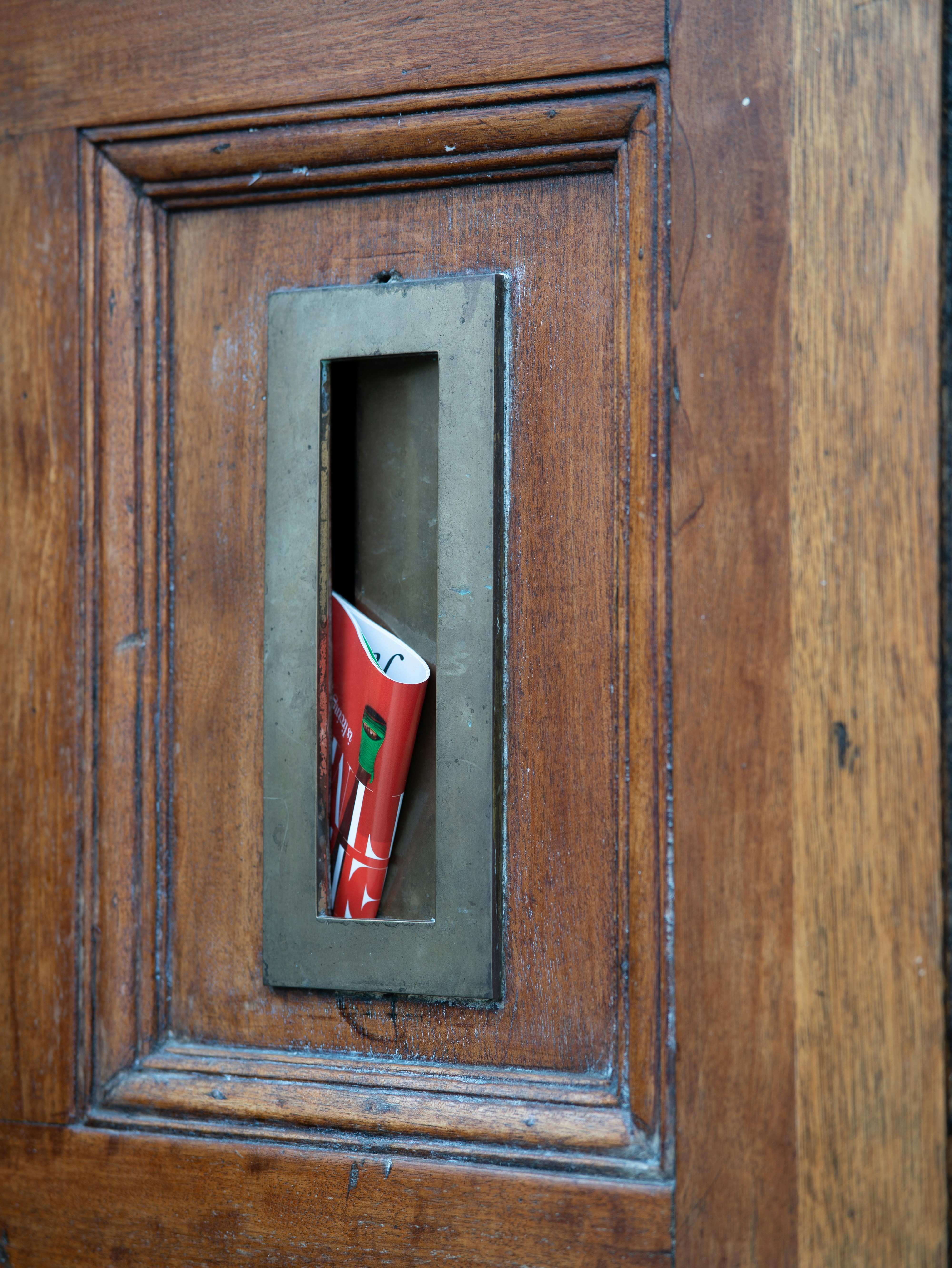 red fire extinguisher on brown wooden doorthe blowup