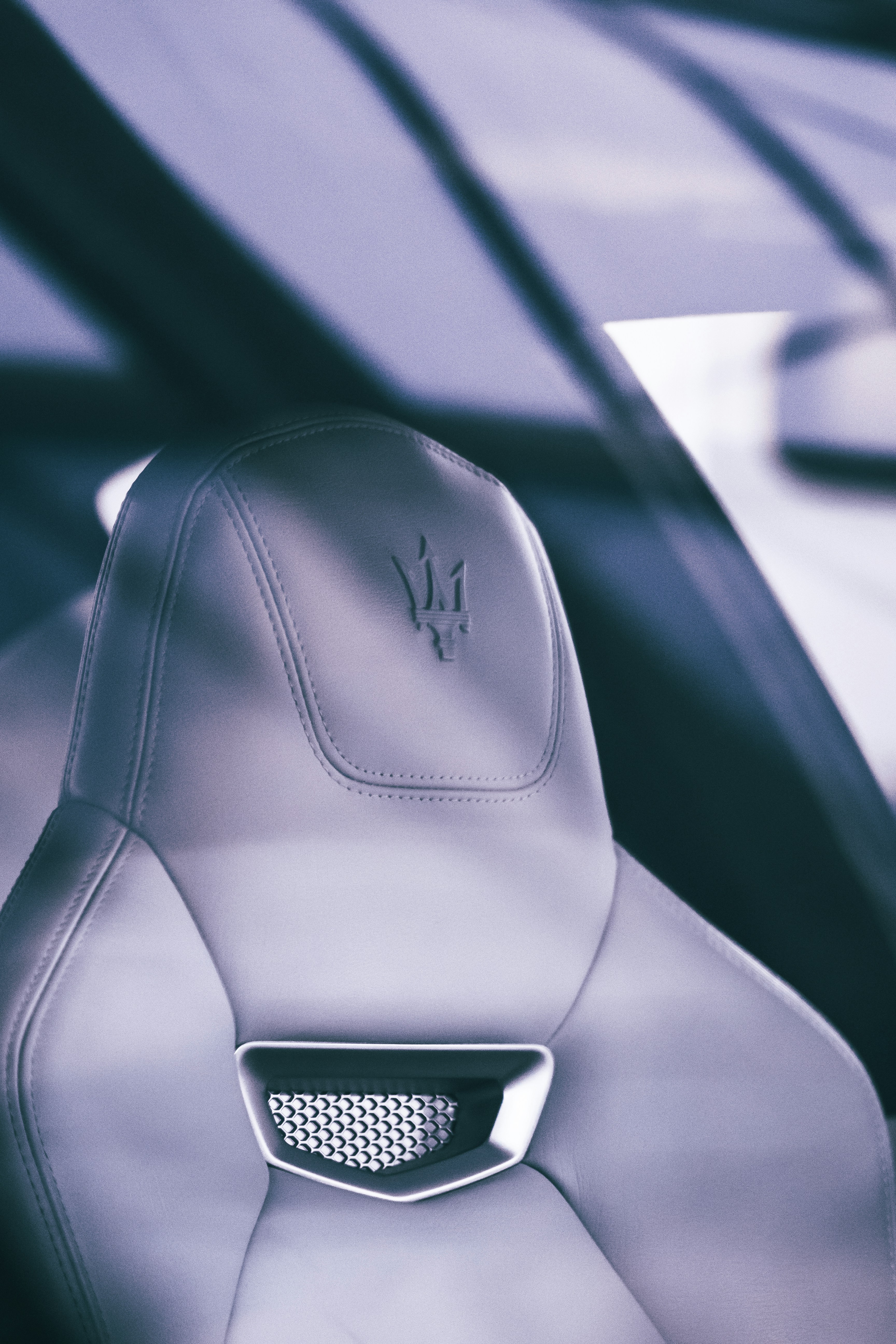 Maserati-inspired car seat silhouette bathed in cool tones