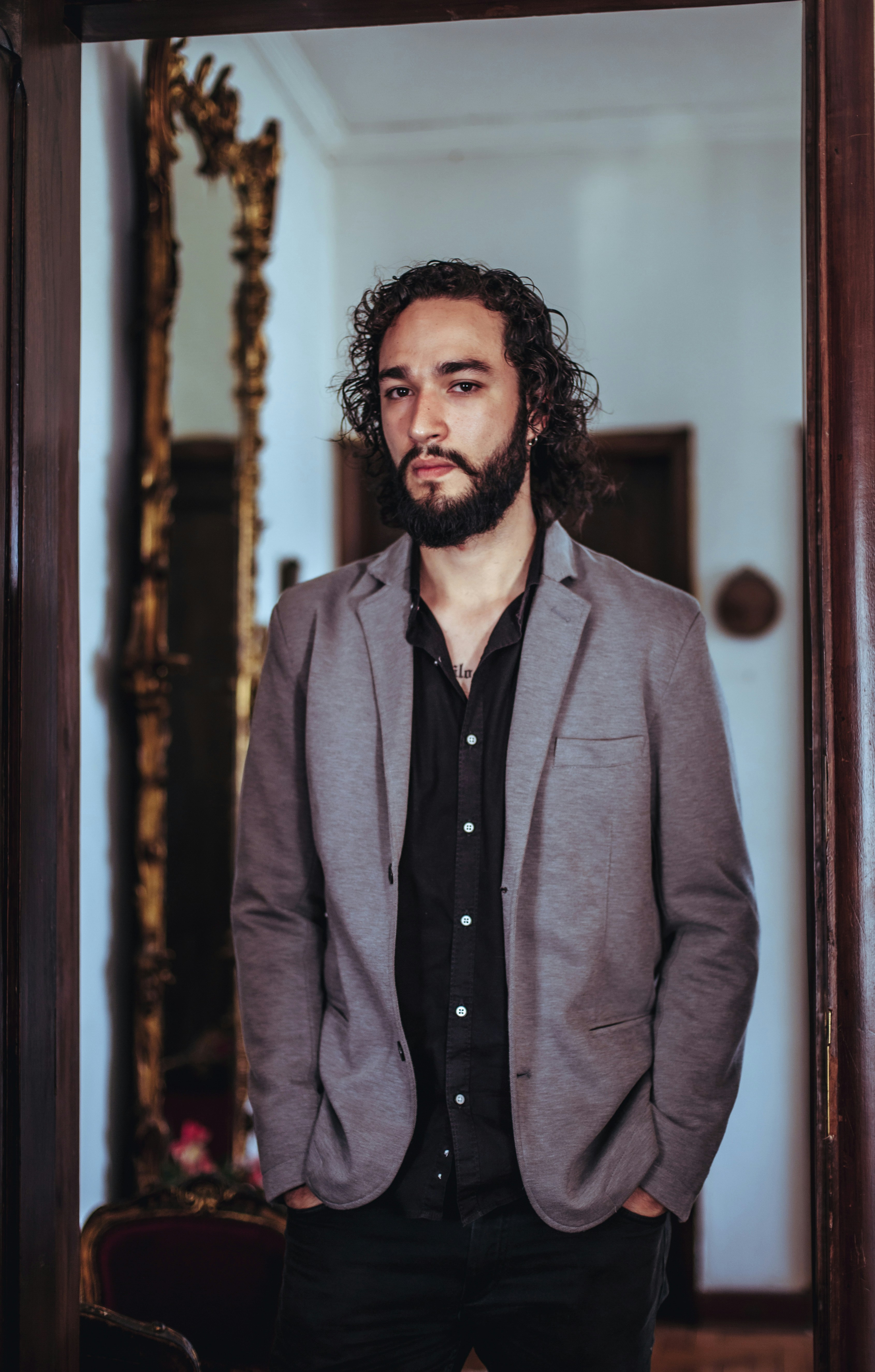 Man in gray coat standing near brown wooden door photo – Free Model man ...