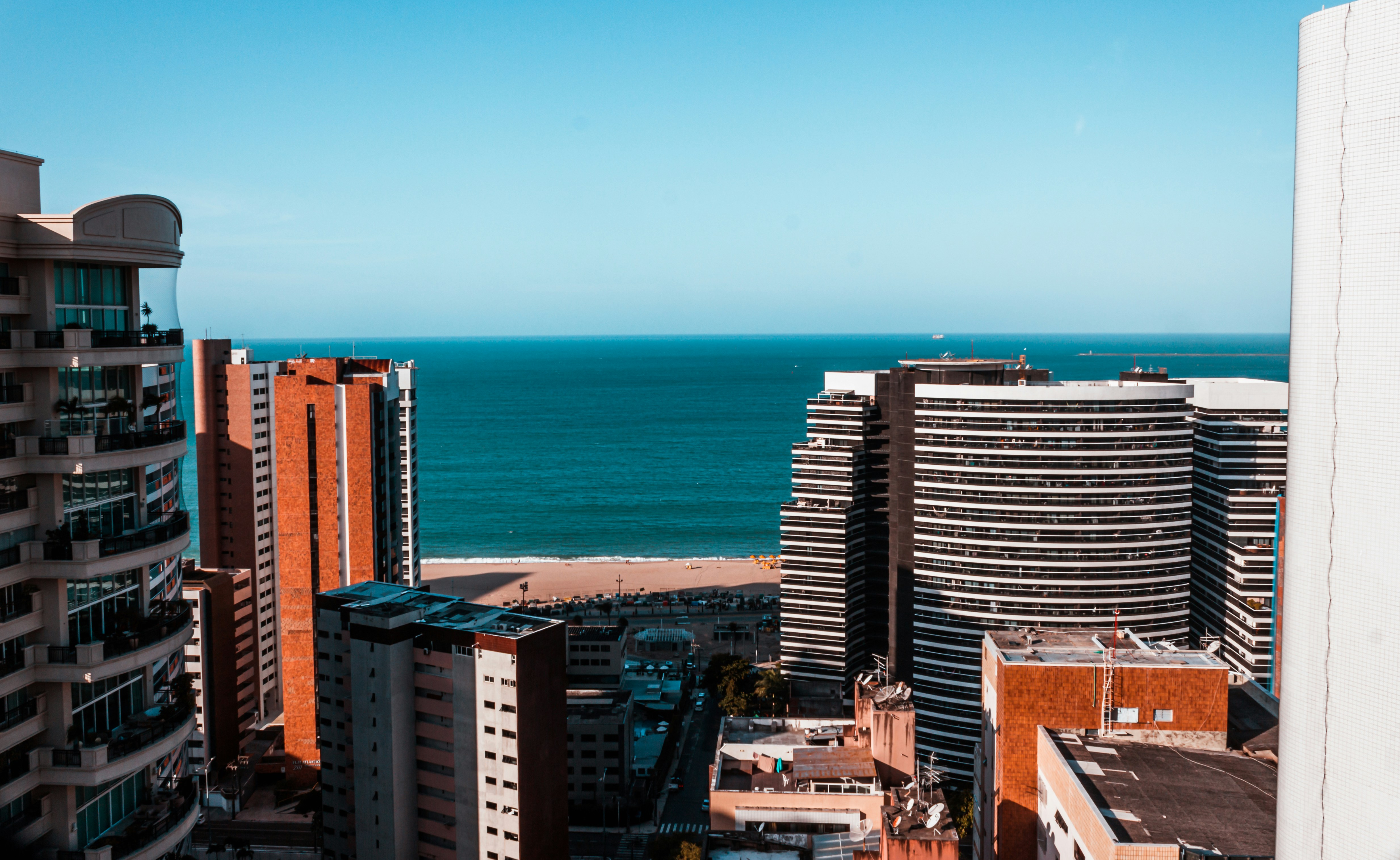 High rise buildings near sea during daytime photo – Free Blue Image on ...