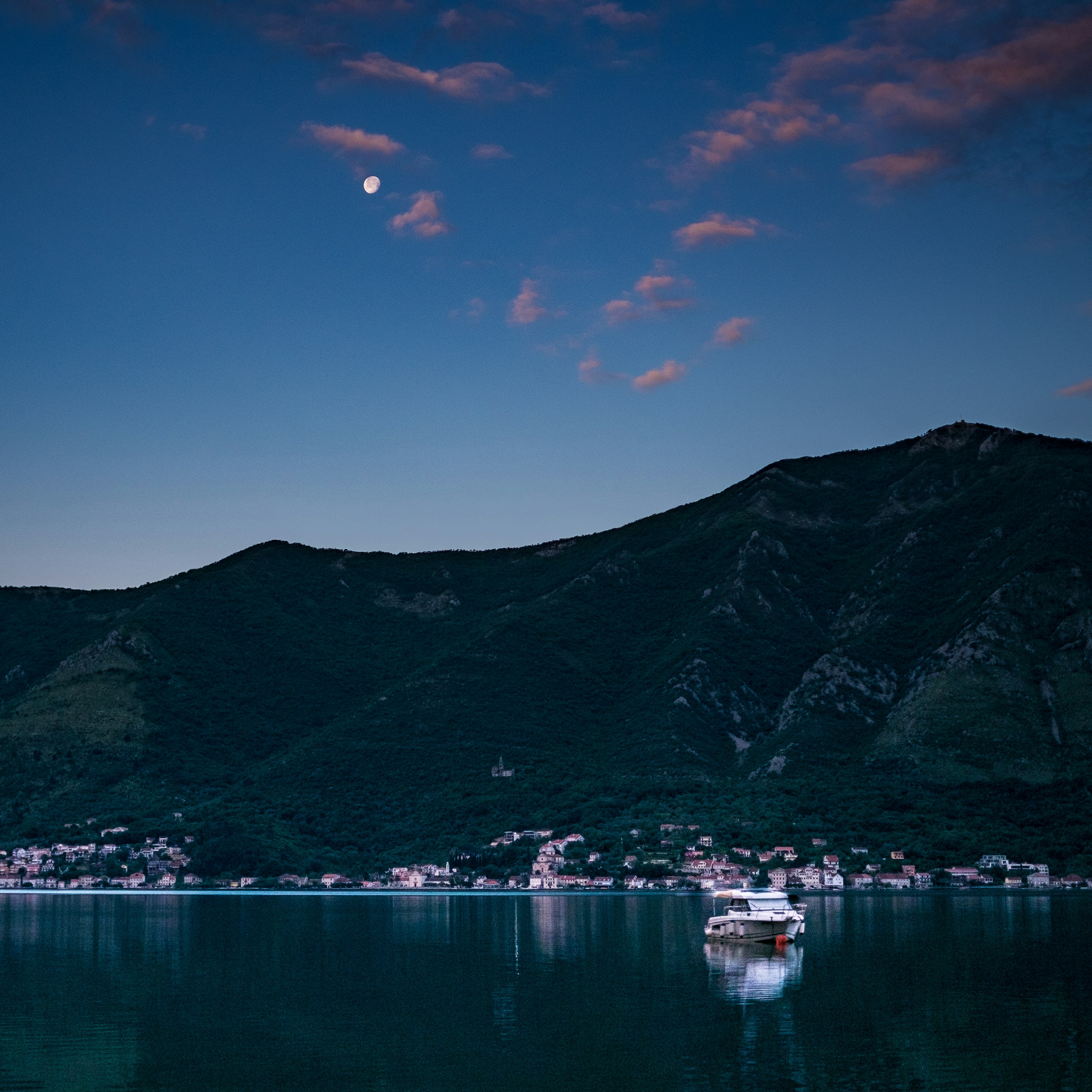 Moonlit Silence Over a Mountain Lake with a Lone Boat