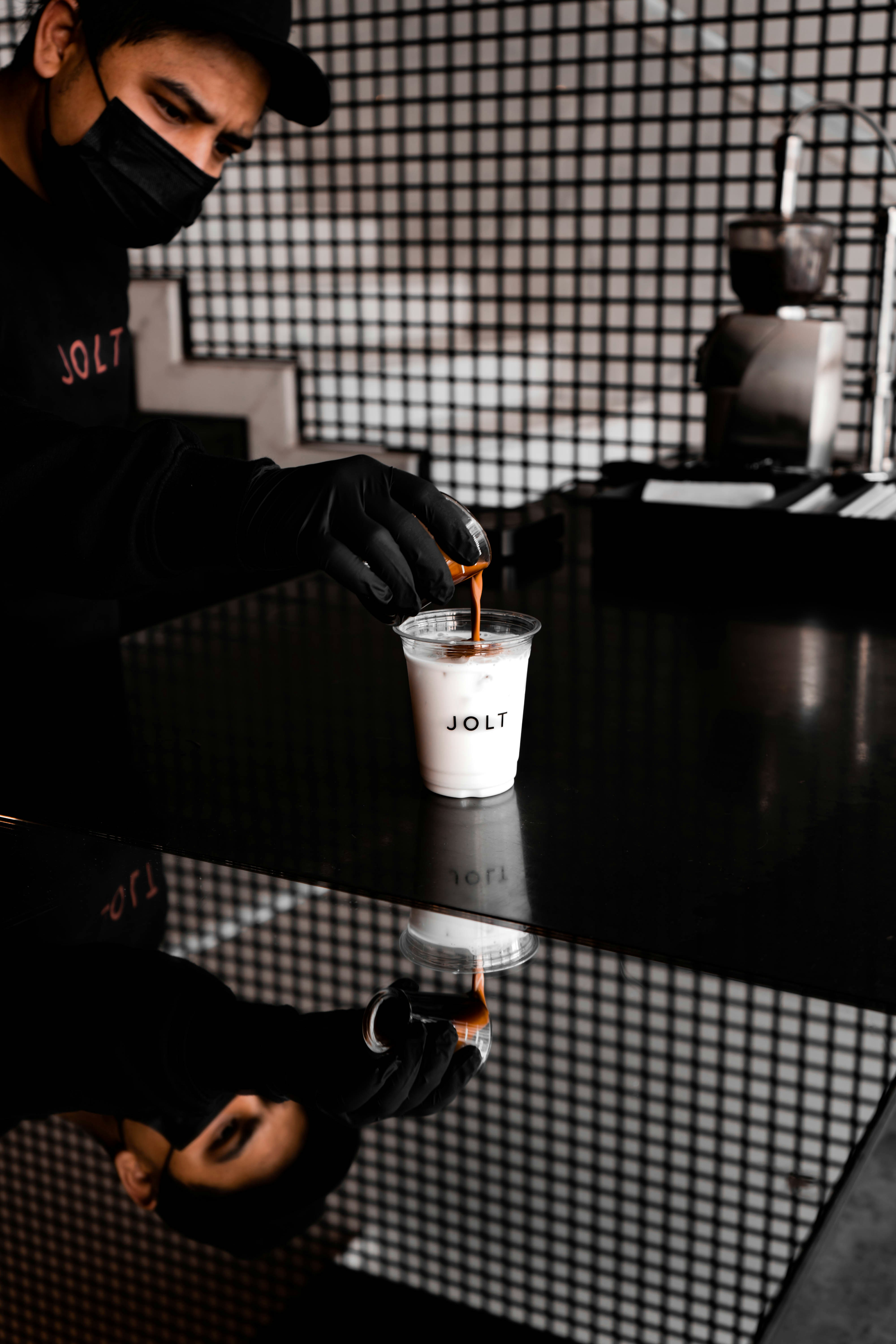 Pouring Precision at JOLT: A Quiet Rite on a Reflective Counter