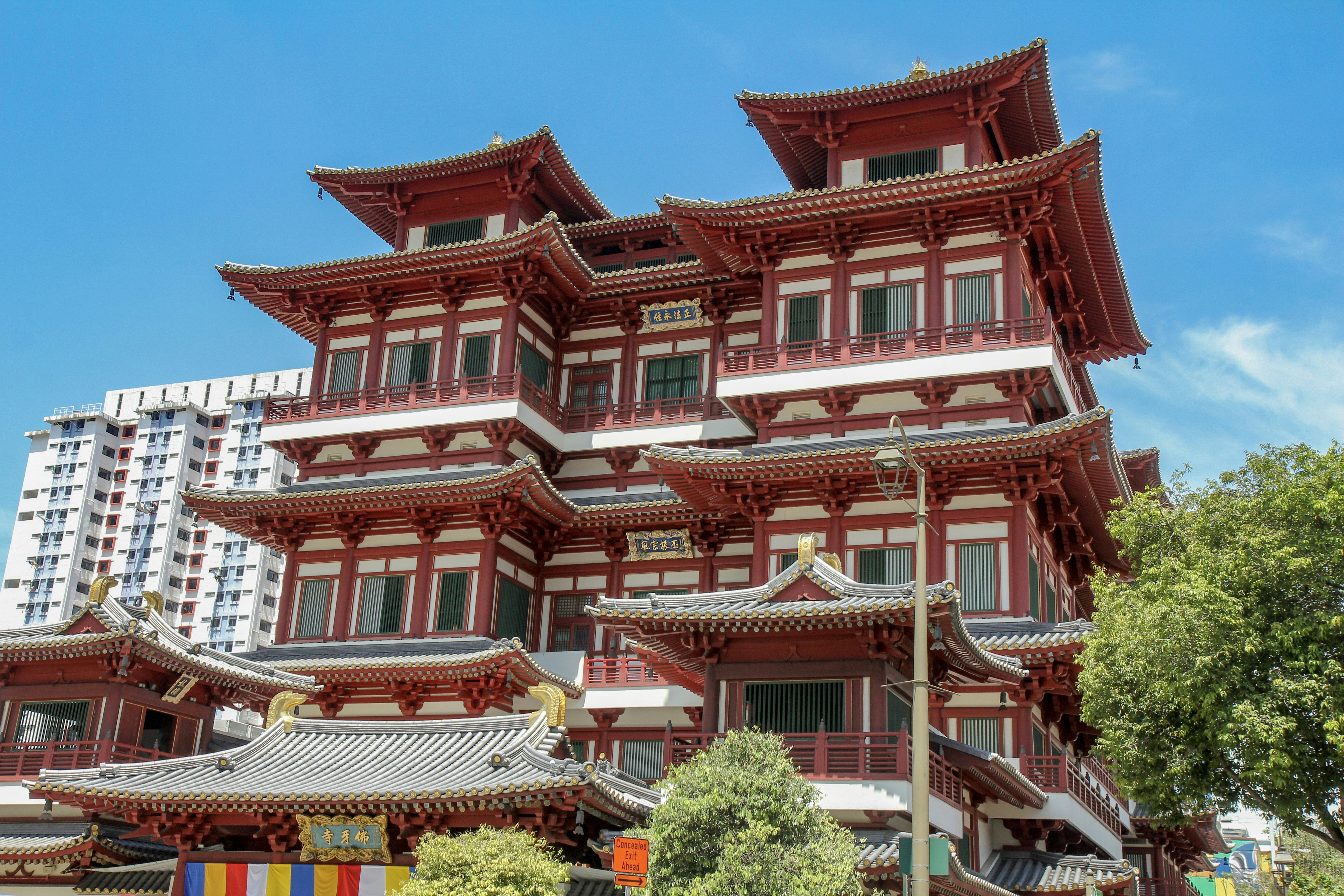 Intricate, multi-tiered traditional building juxtaposed against a modern skyline, showcasing the blend of cultural heritage and contemporary design.
