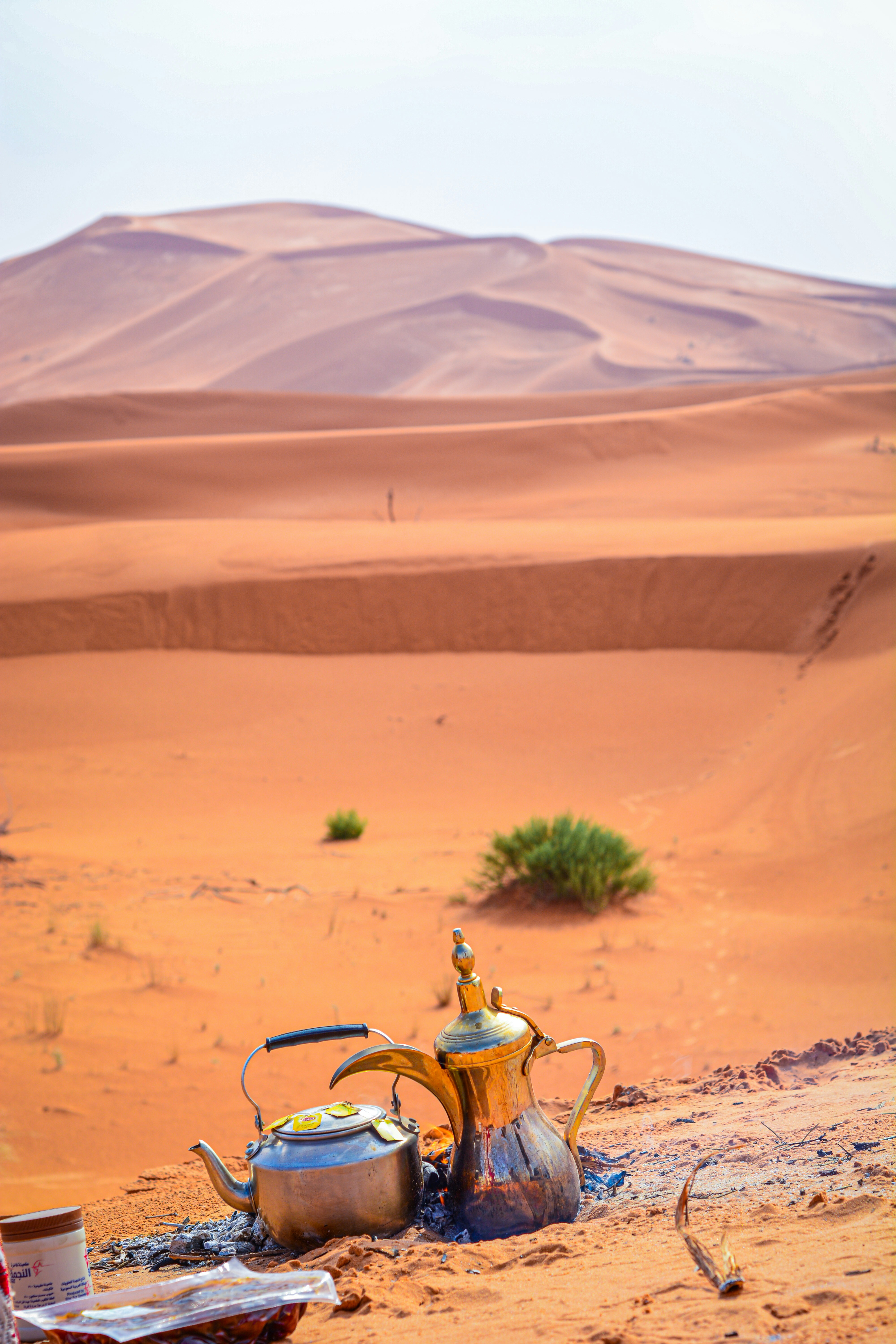 Desert Tea Set in Silence: A Glint of Copper Against Red Dunes