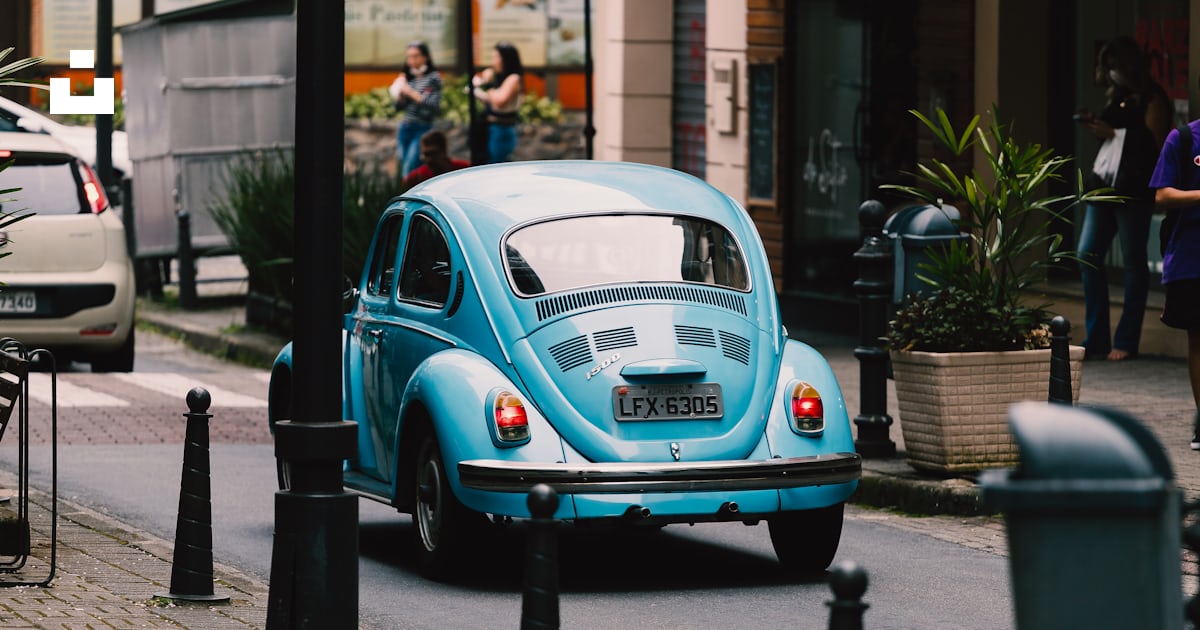 Teal Volkswagen Beetle Parked On Sidewalk During Daytime Photo Free