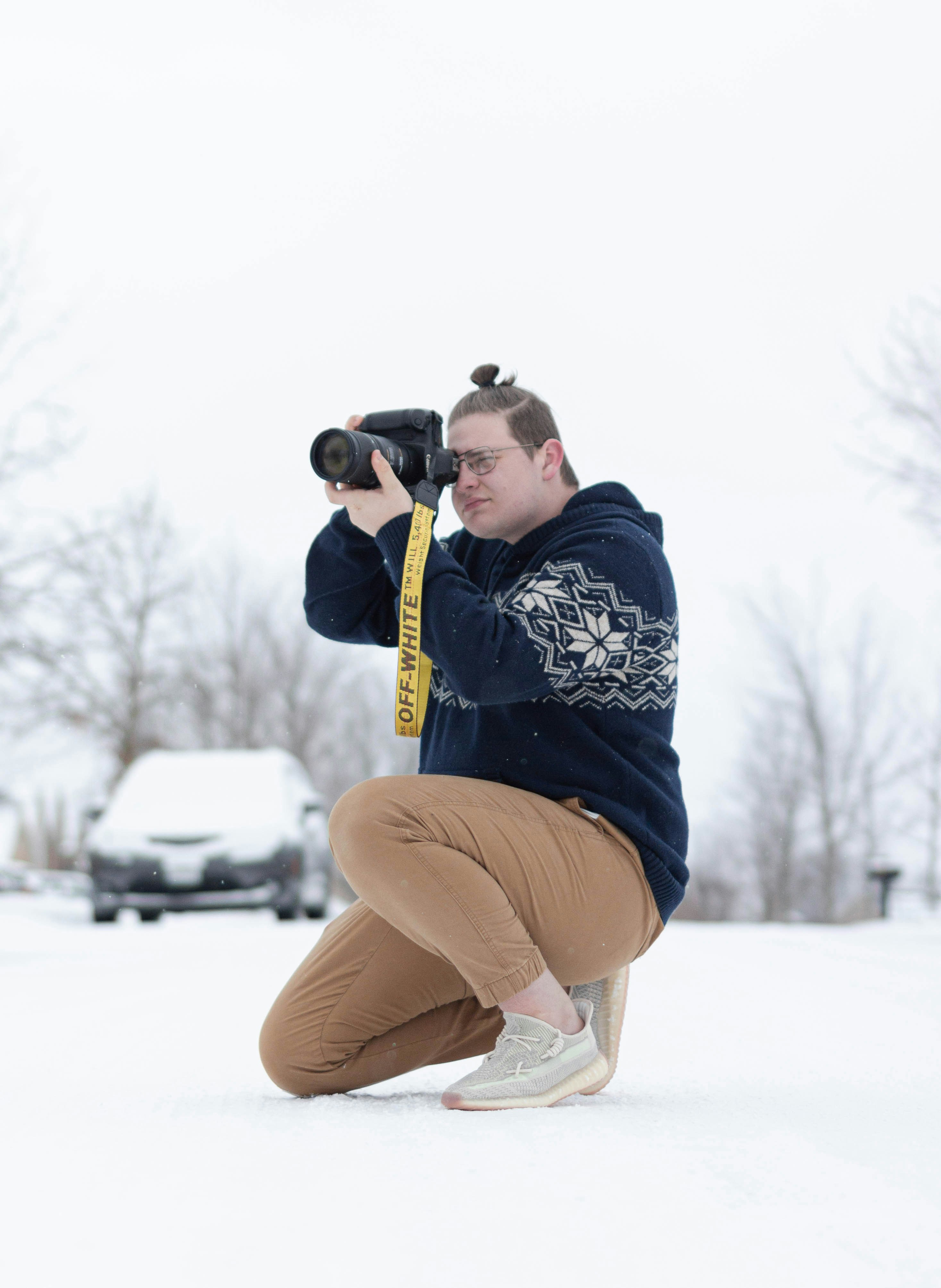 Winter Focus: A Photographer Kneels to Capture Silence in Snow