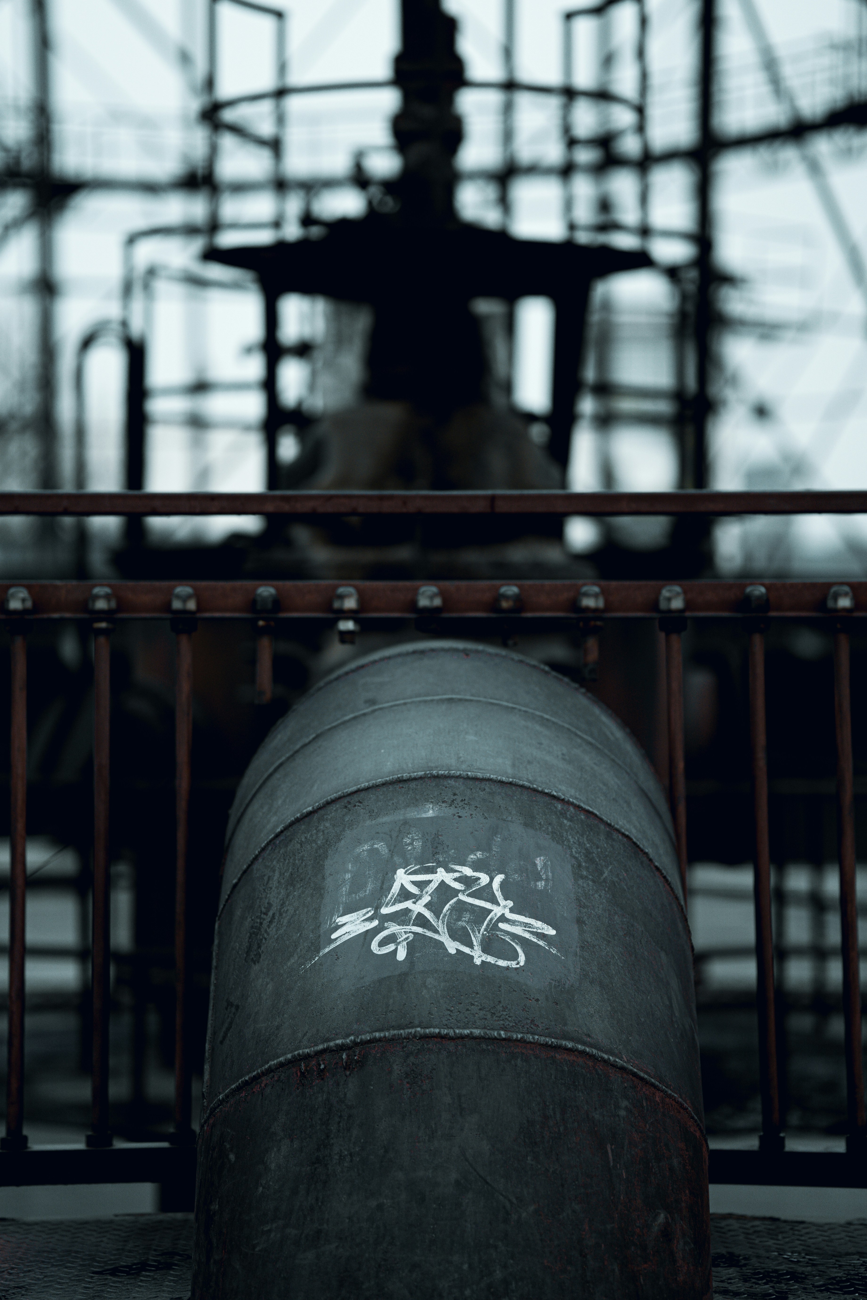 Graffiti on a Weathered Industrial Pipe in a Silent Rig
