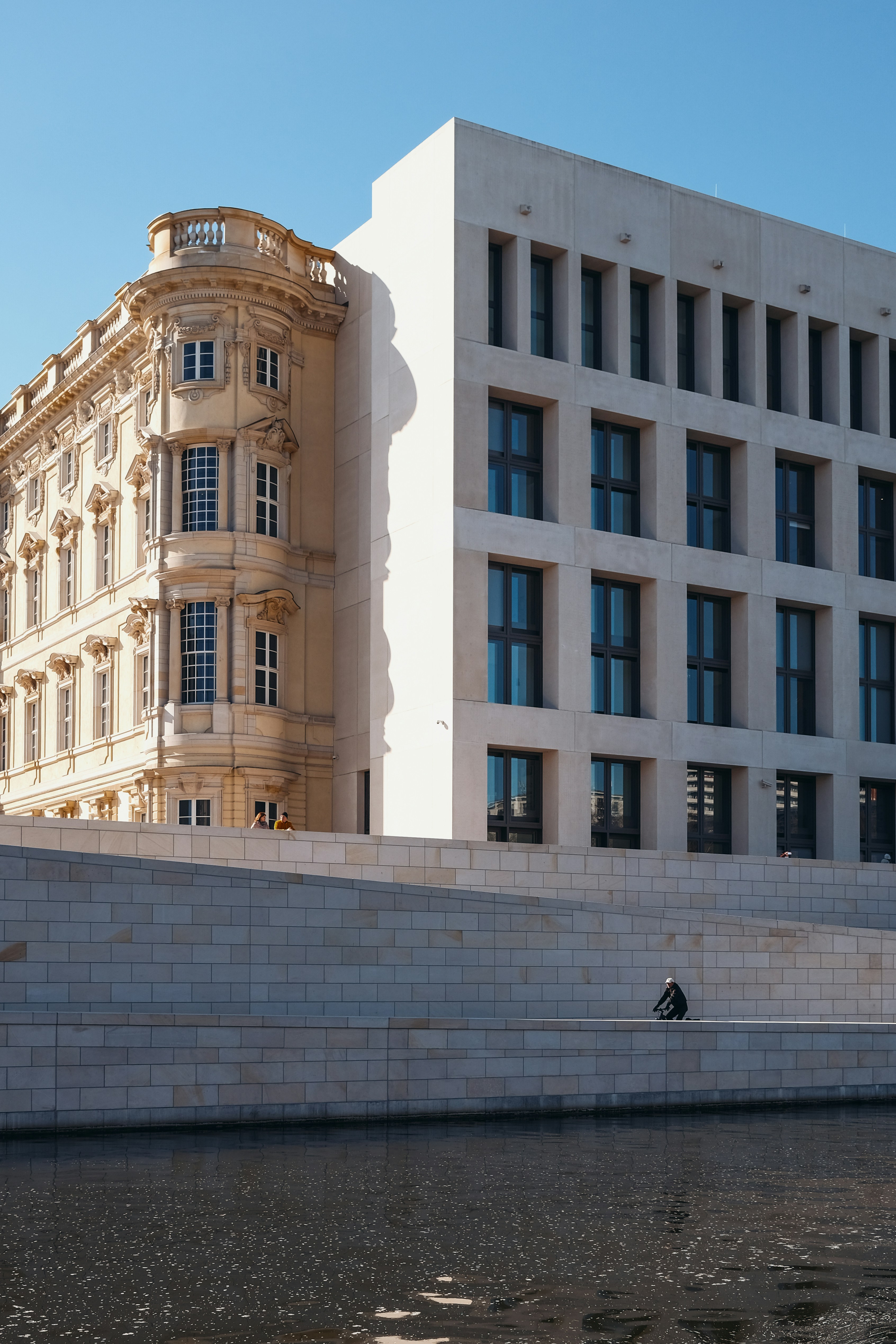 Corner Contrasts: The Neoclassical Curve Beside a Modern Facade