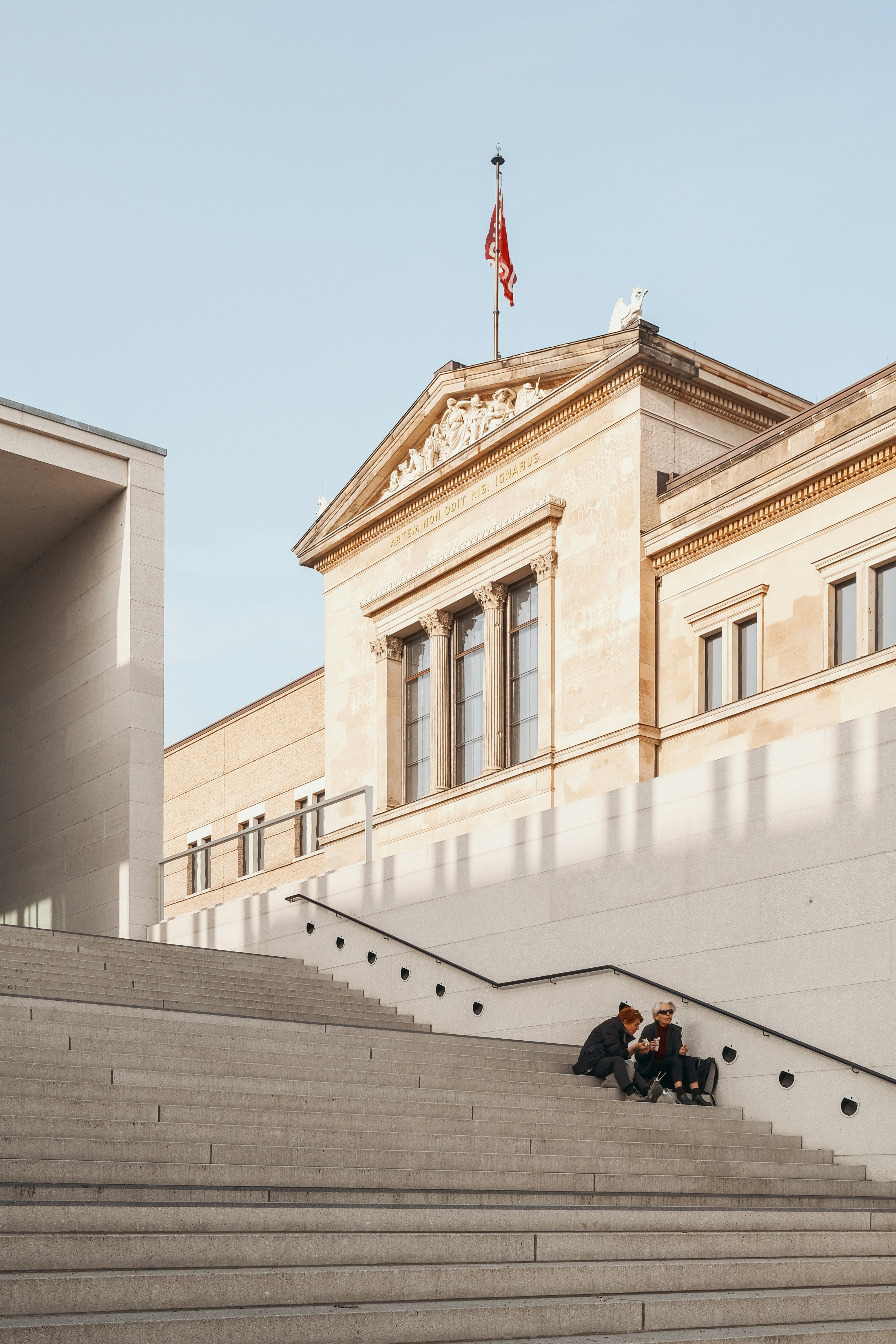 Whispers on the Civic Staircase Beneath a Classical Facade