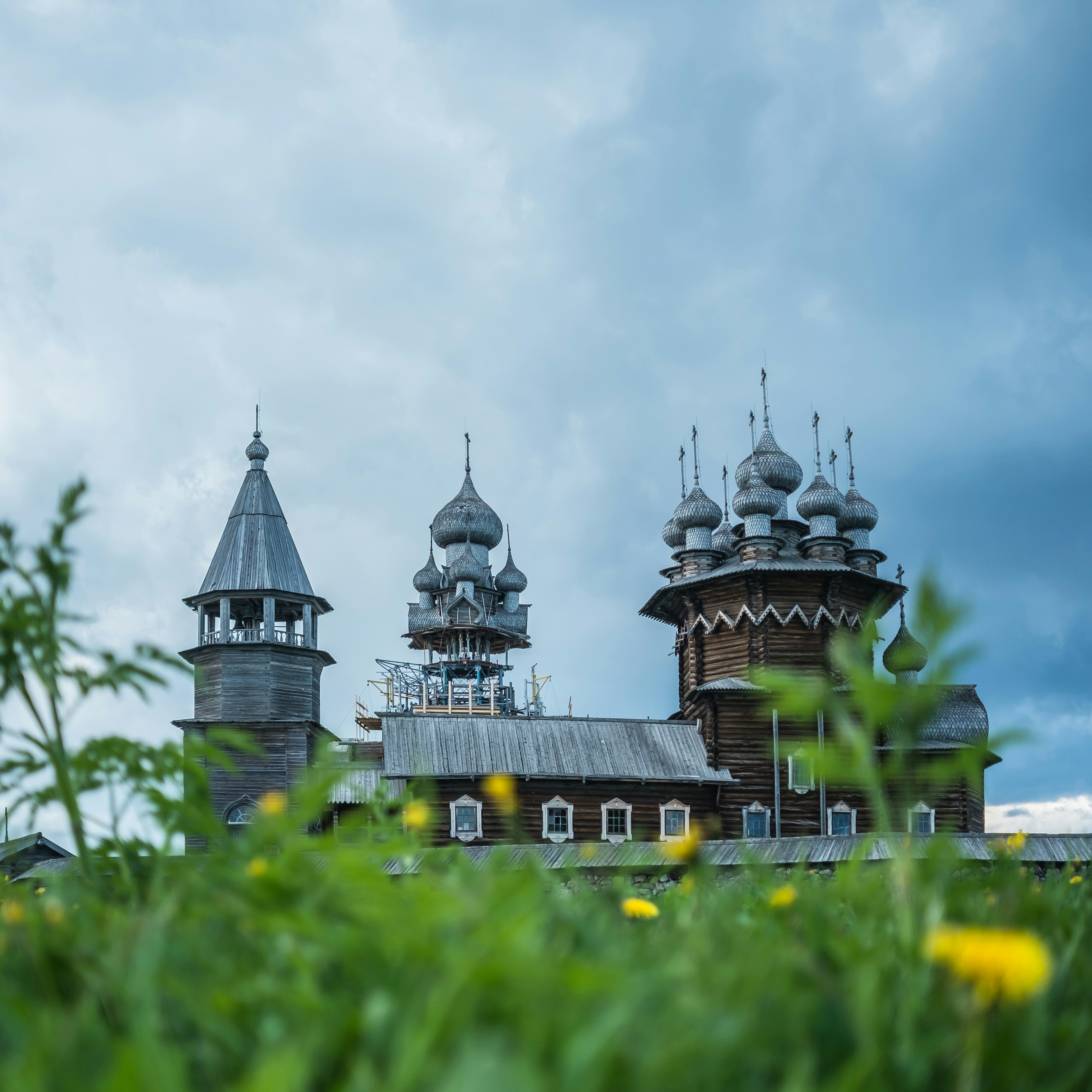 Wooden Orthodox Skyline: A Stacked Tapestry of Onion Domes Against Stormy Light