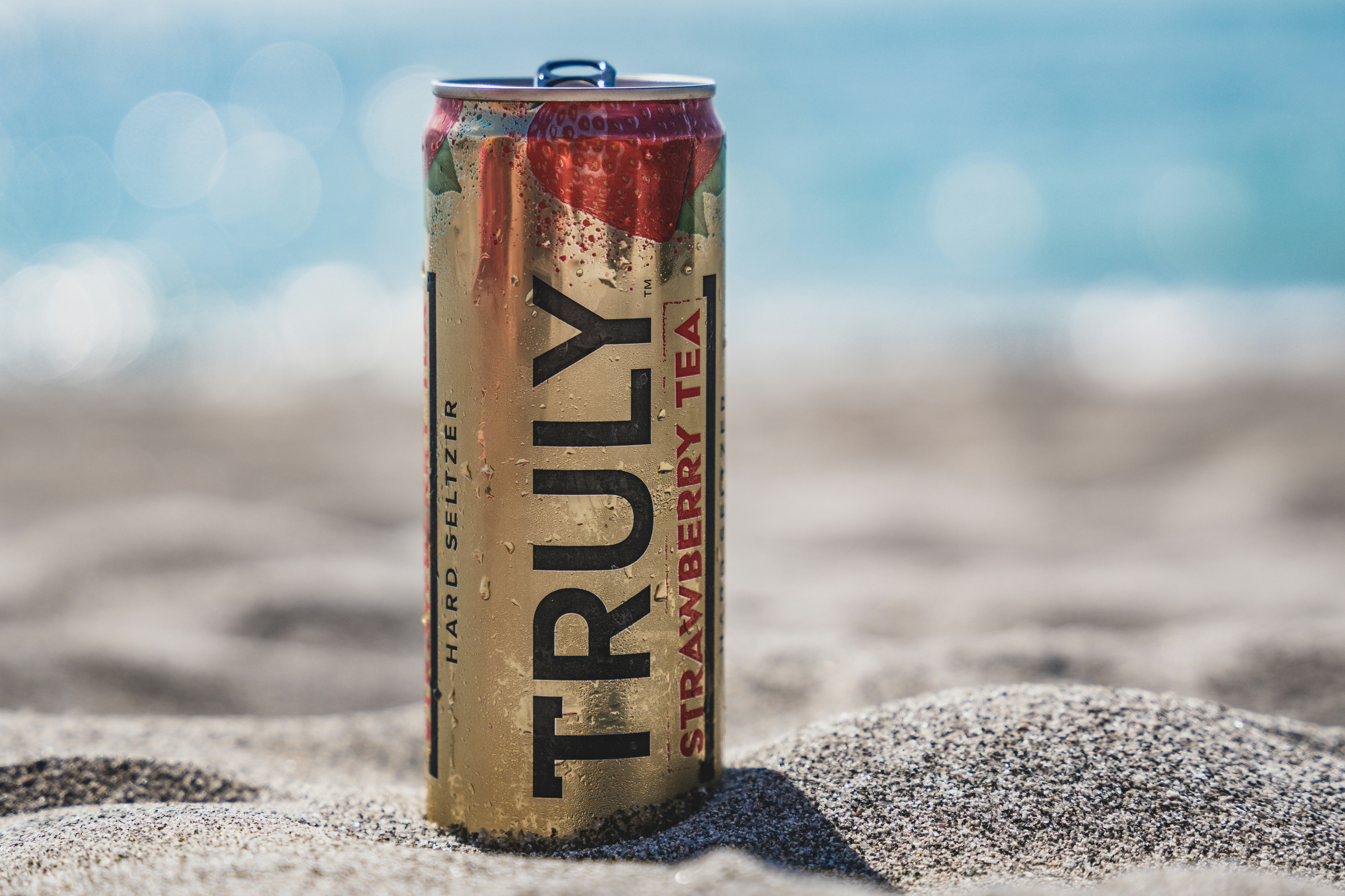Amped on the Beach: a can of STRULY on sunlit sand