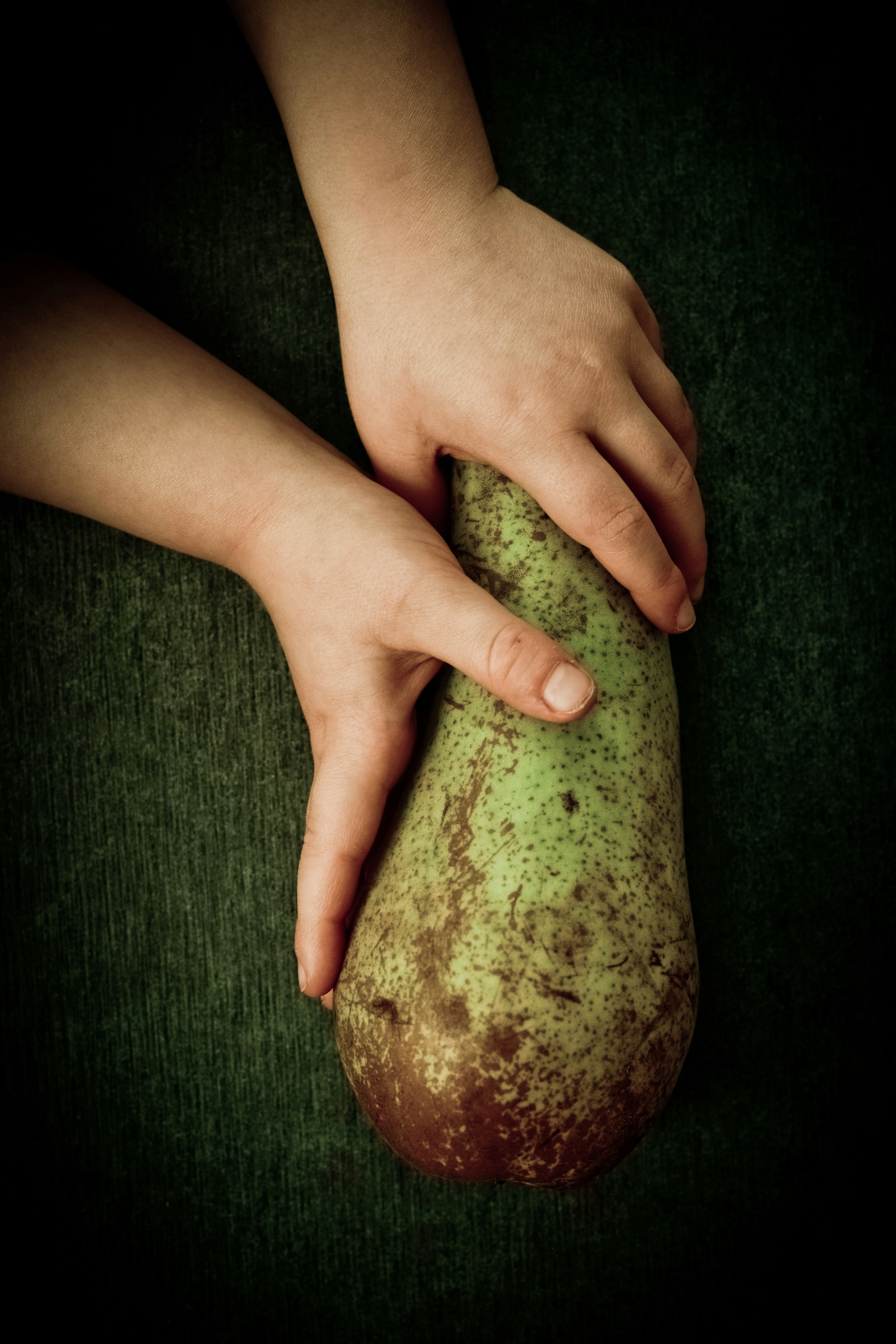 Cradled Pear: A Quiet Still-Life in Velvet Green Light