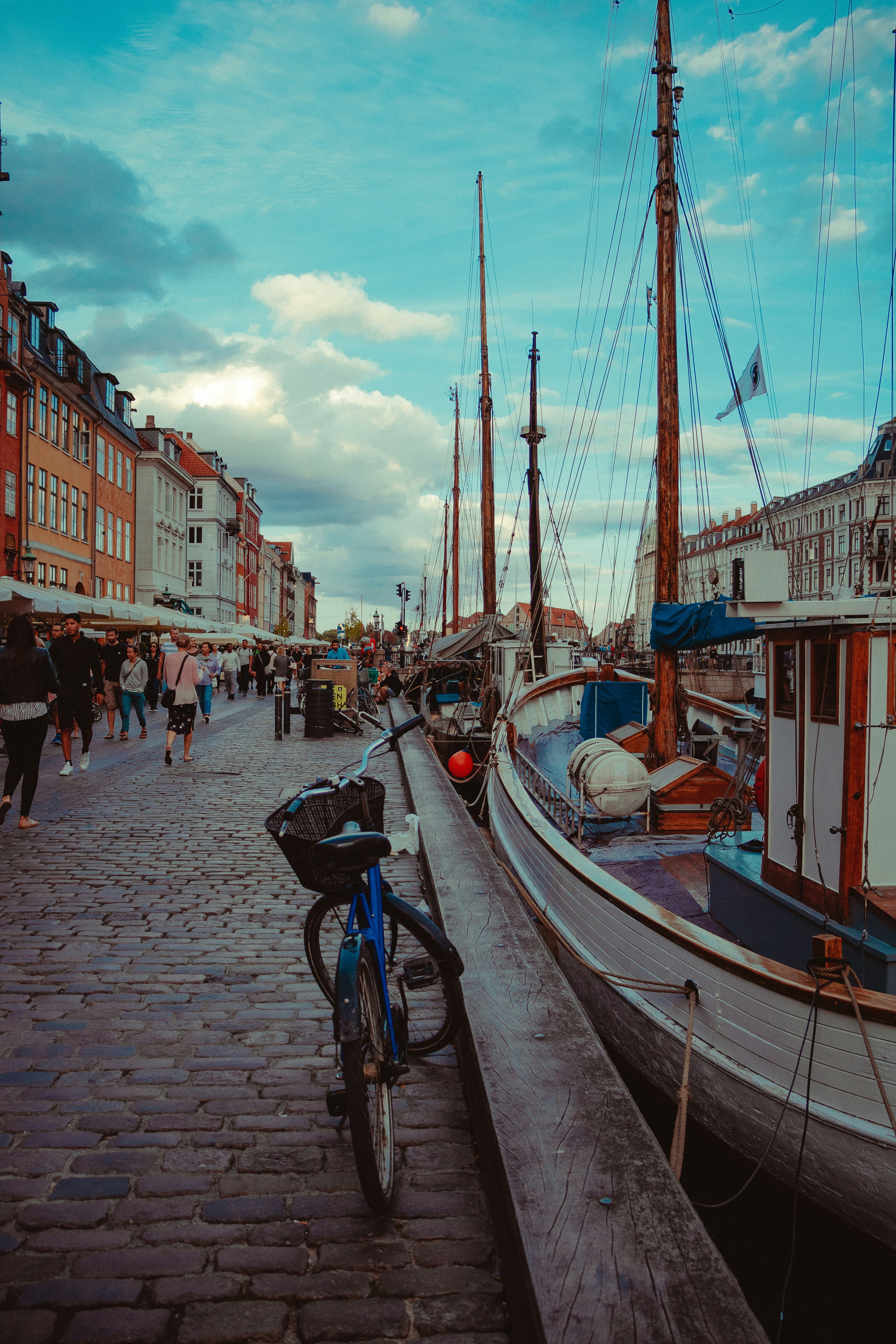 Cobalt Bicycle by the Harbor: Cobblestones, Sails, and Evening Light