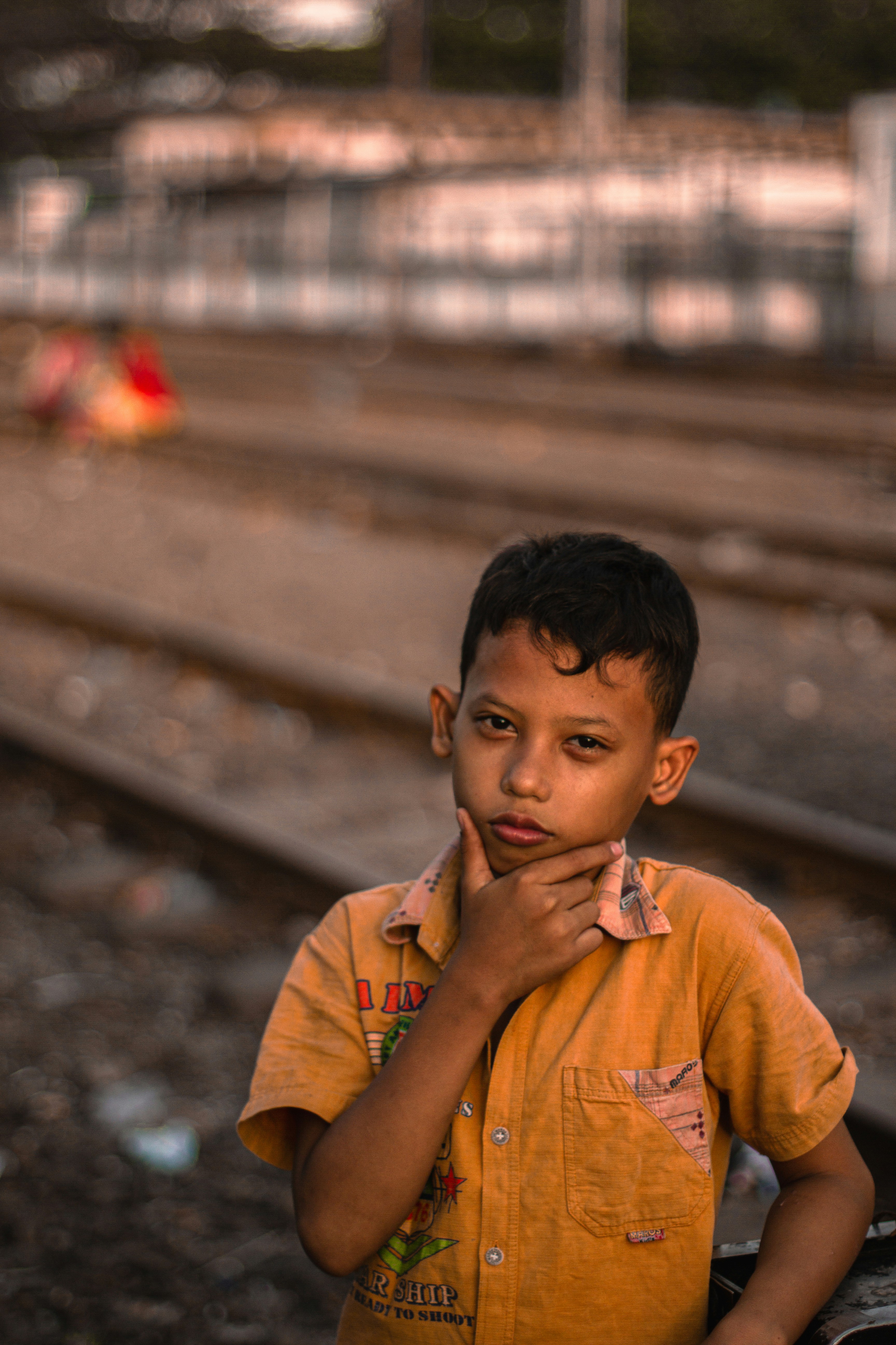 Glimpse on the Rails: a boy's pensive moment at dusk