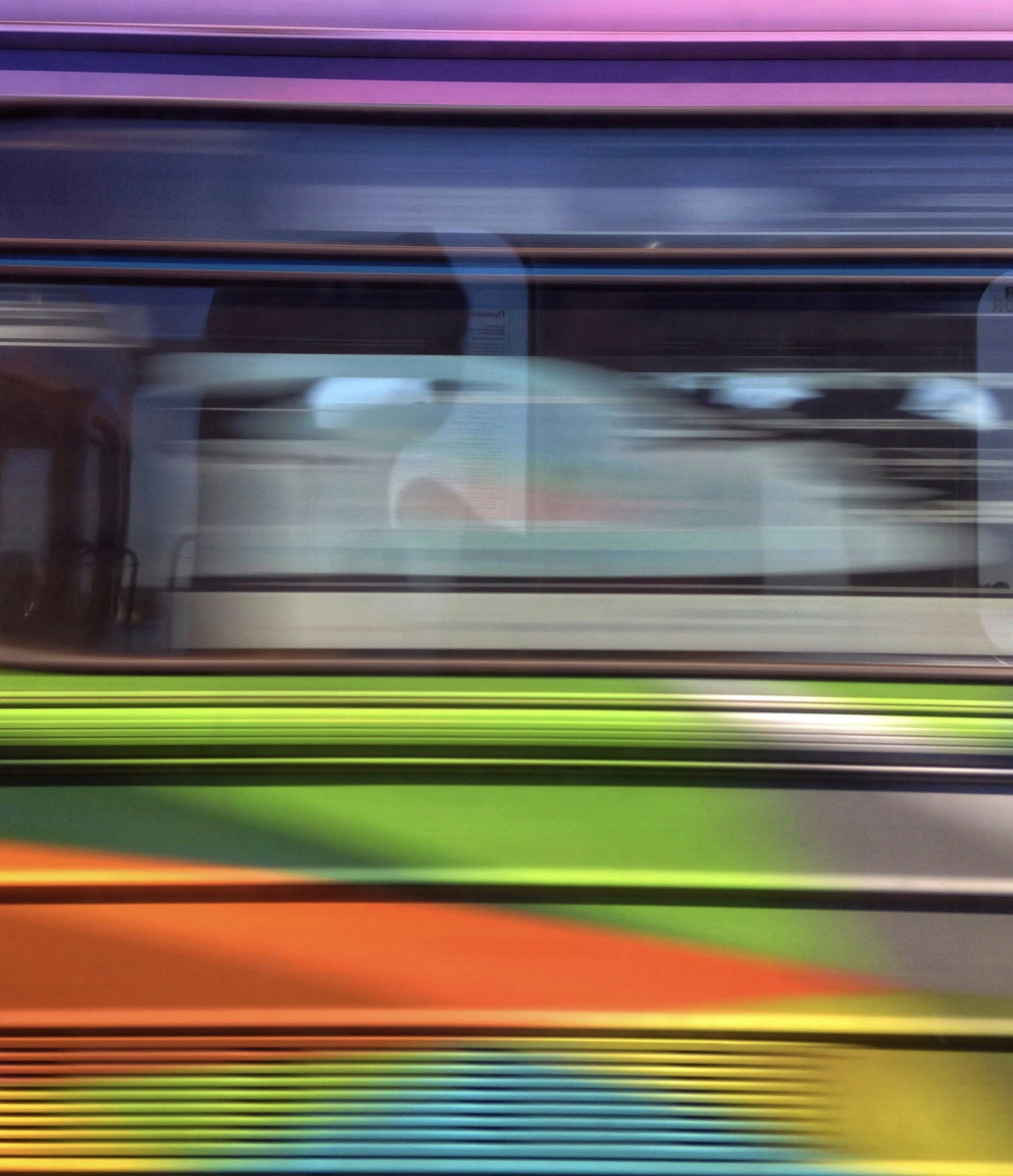 Chromatic Blur: A Train Car’s Rainbow Horizontal Surge
