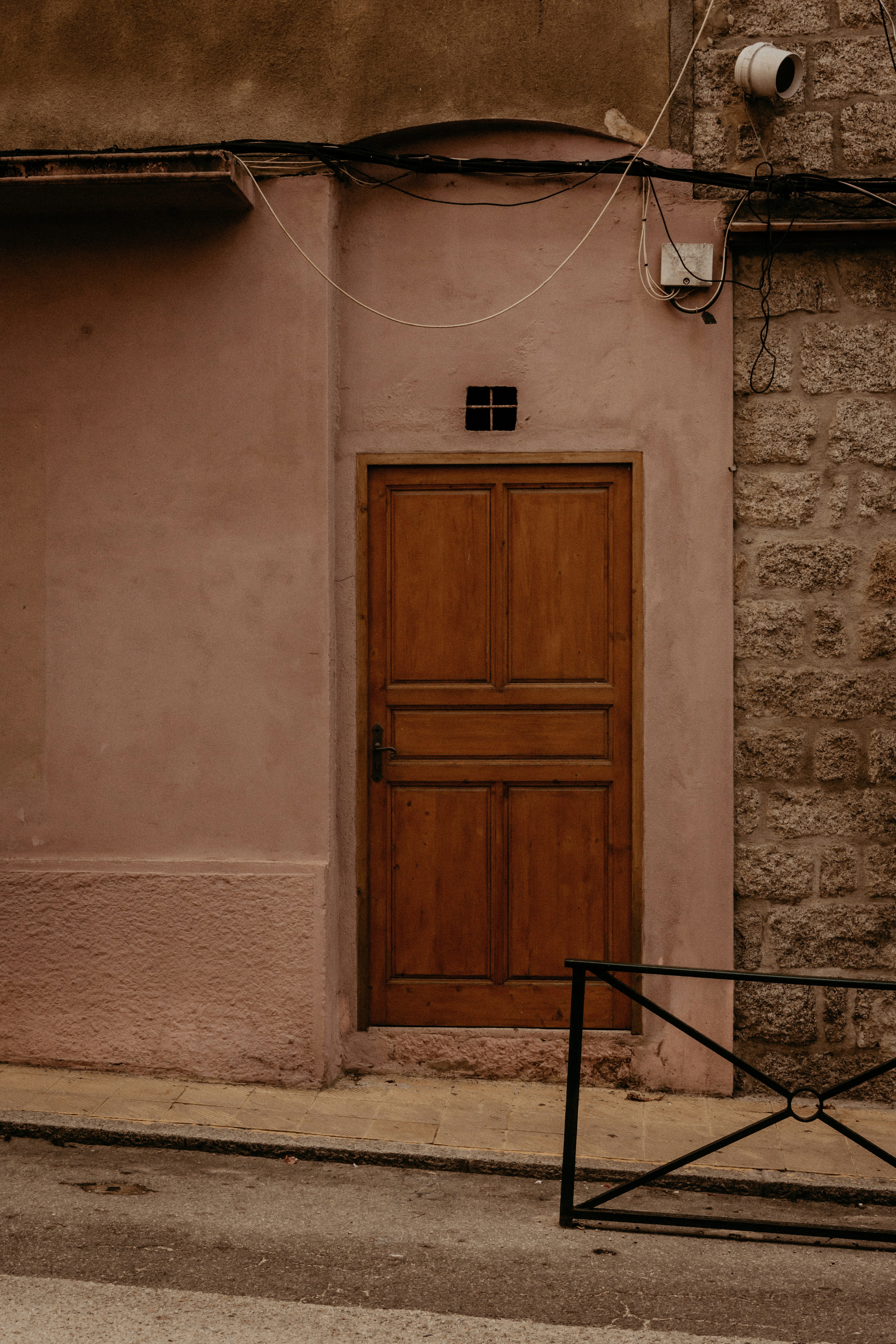 brown wooden door on gray concrete wall