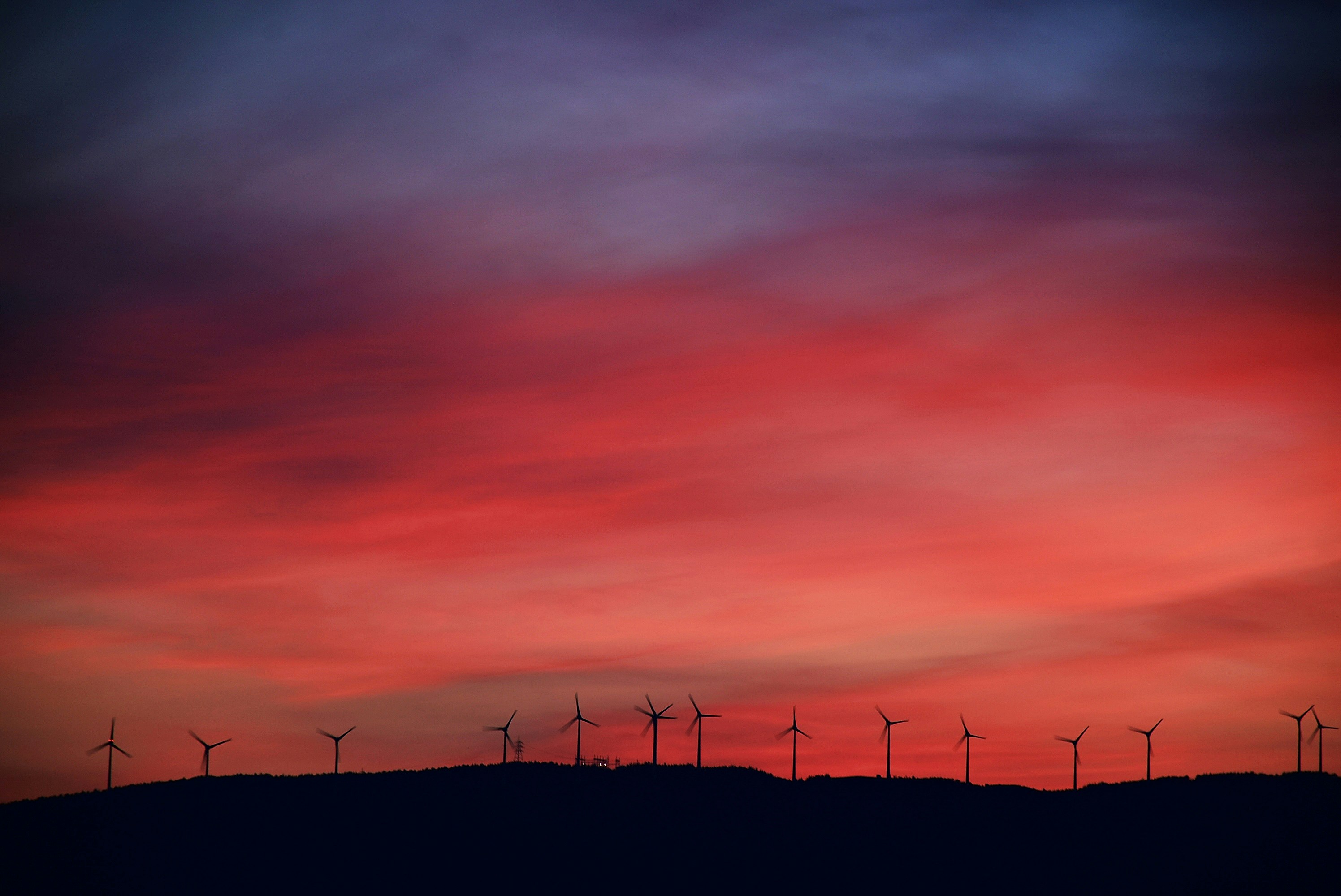 sunset | silhouette of wind turbines during sunset