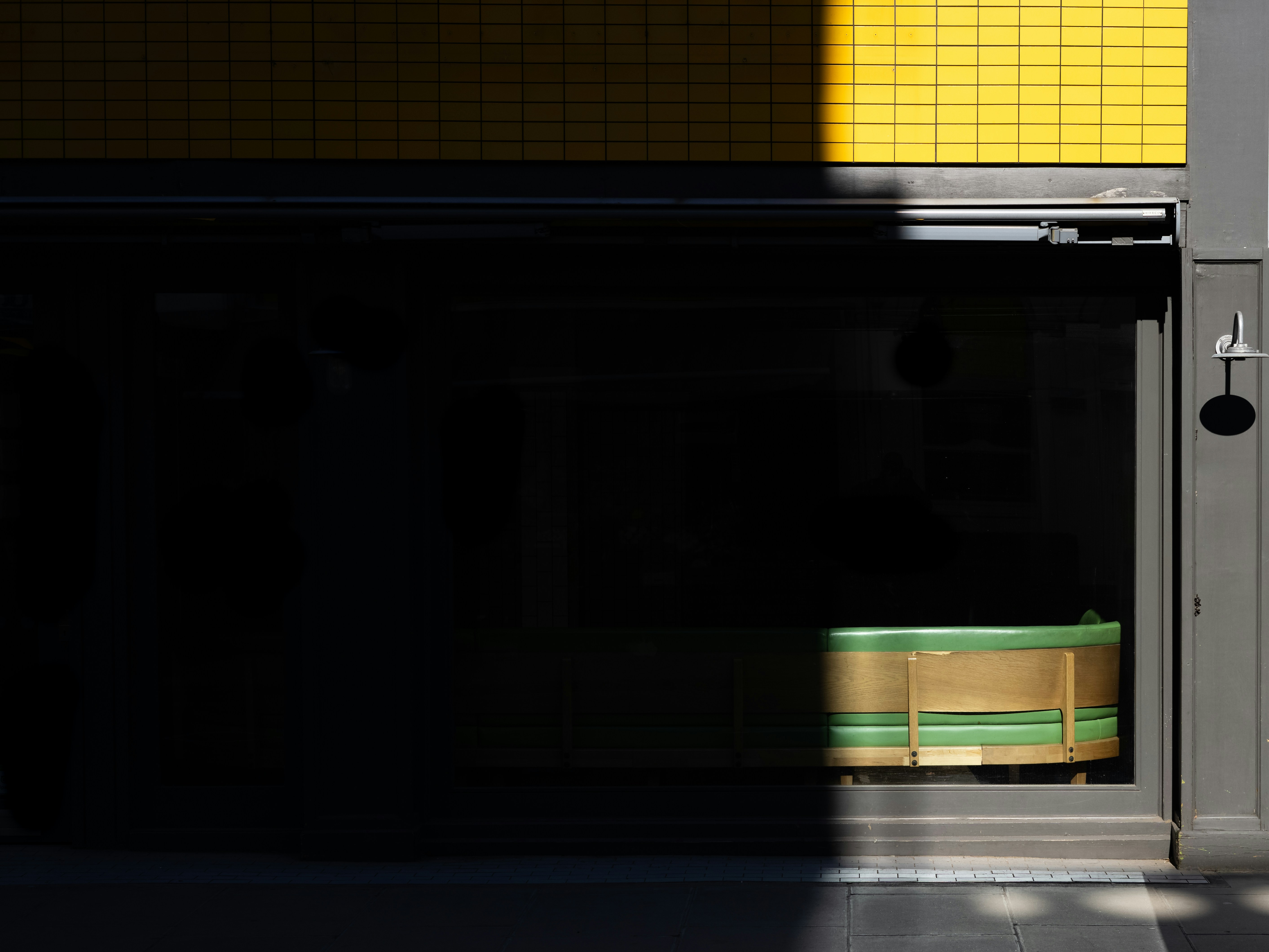 Sunlit Bench Hidden in Shadowed Garage
