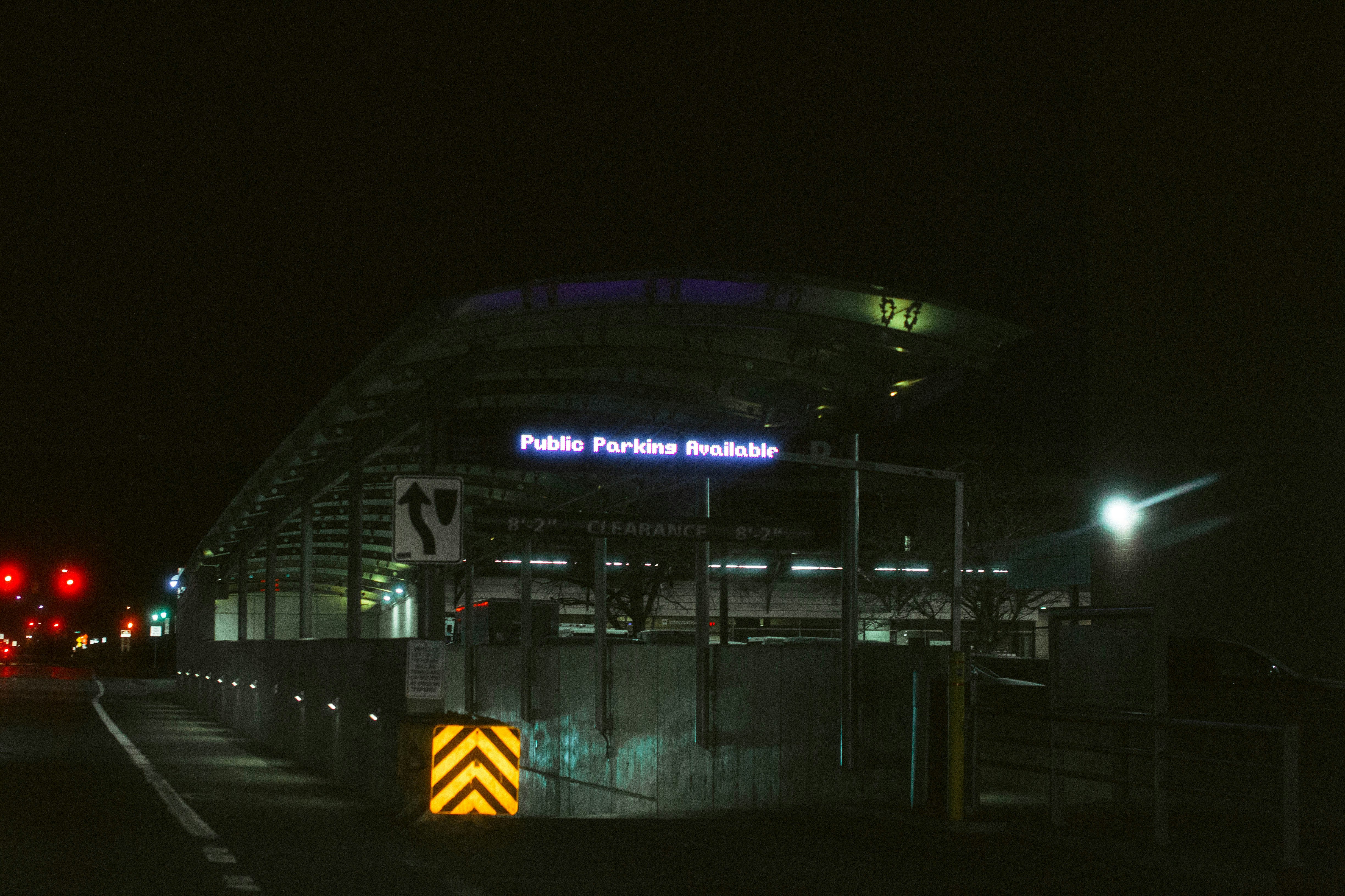 Night-Shift Sign: Public Parking Available Illuminates a Quiet Garage Entrance
